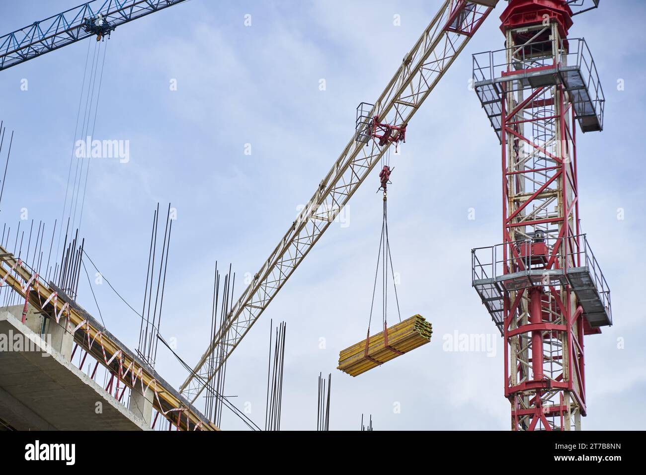 Construction of new buildings using a crane. Tower crane. Skyscrapers ...