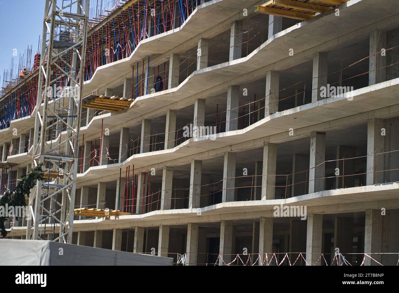 A high-rise building under construction with reinforced concrete walls ...