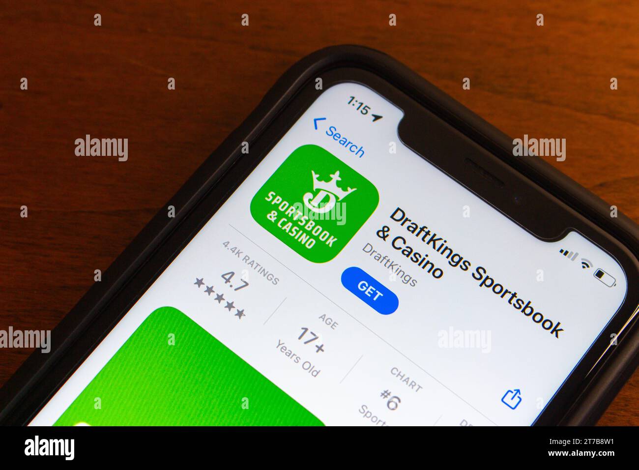 DraftKings app seen in App Store in iPhone screen. DraftKings is an US ...