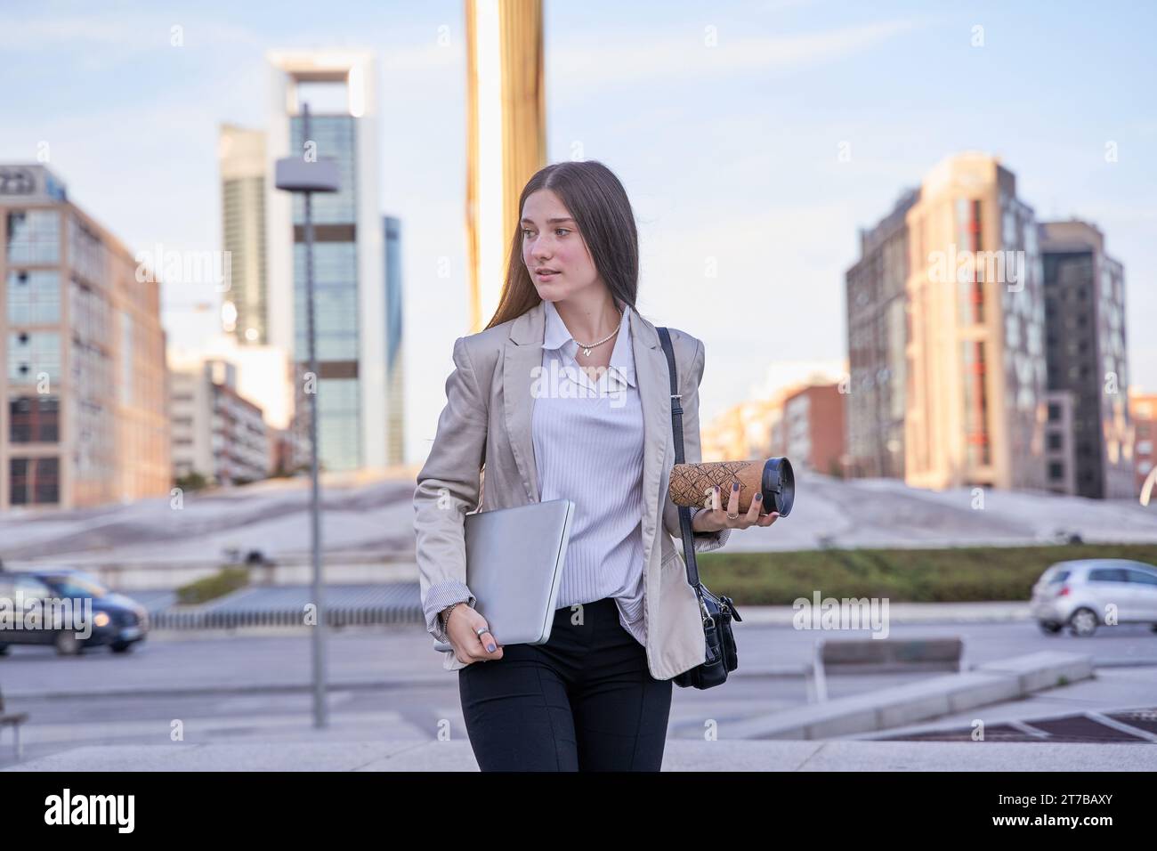 young student walking with his laptop computer Stock Photo - Alamy