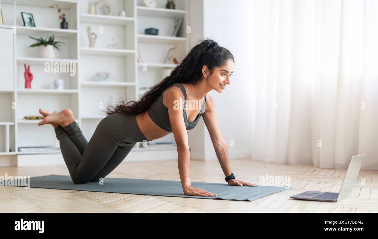 Sporty Millennial Indian Woman Undertaking Digital Exercise Session ...