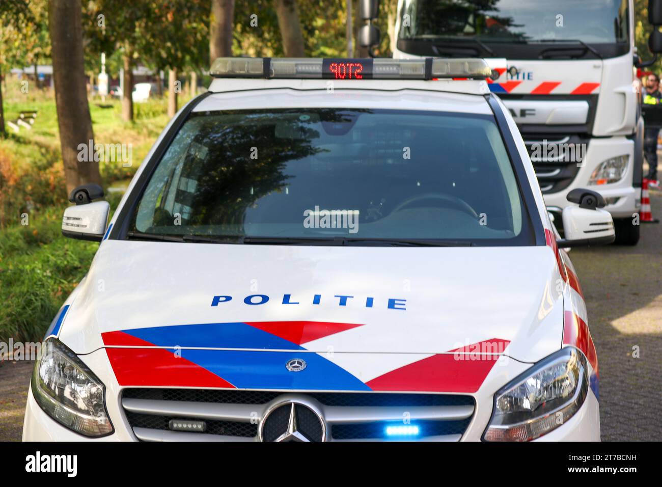 Police car in the Netherlands with blue flashlights and stop sign lit ...