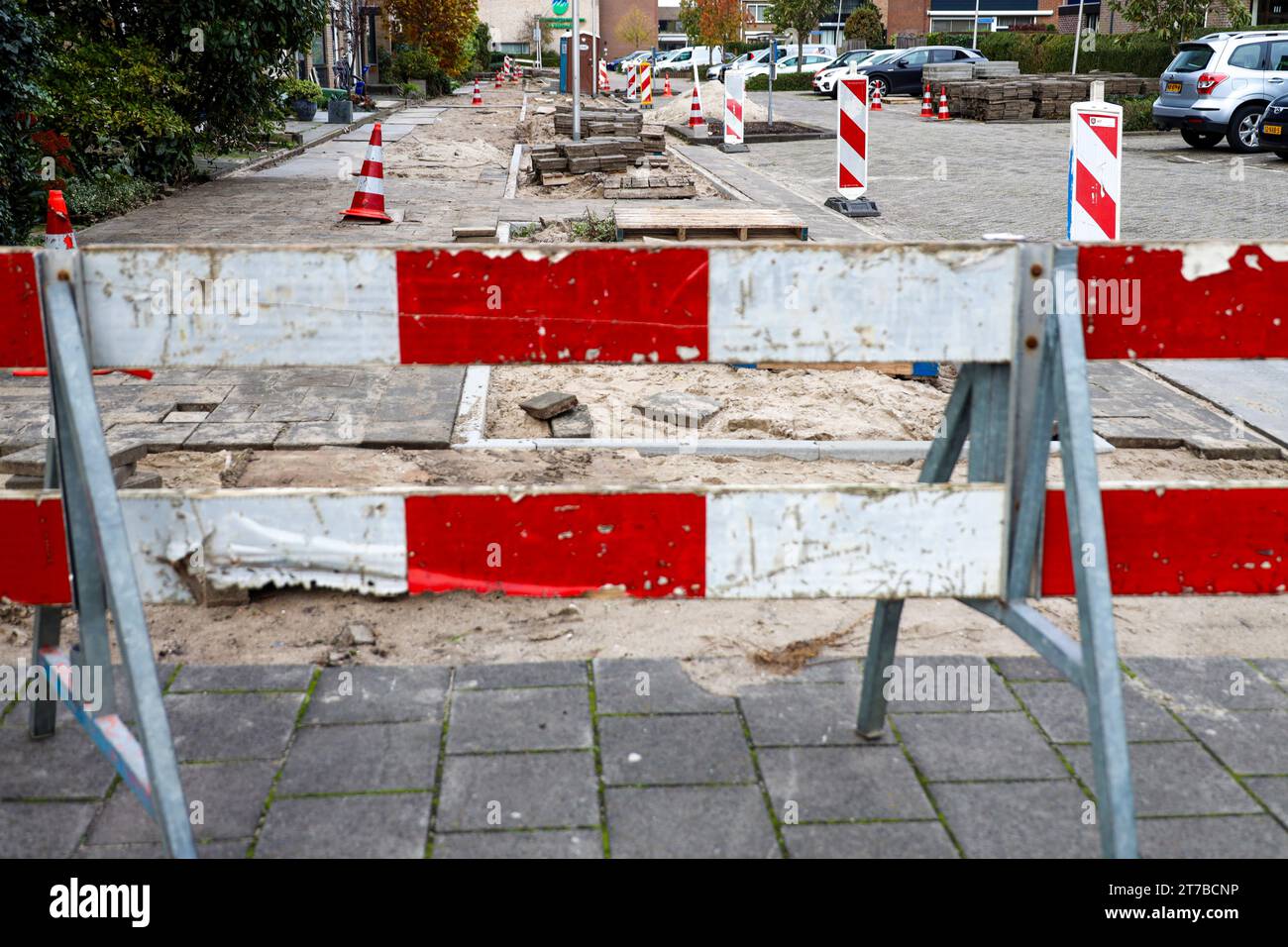 Reconstruction of tiles and planters on a sidewalk in Nieuwerkerk aan ...
