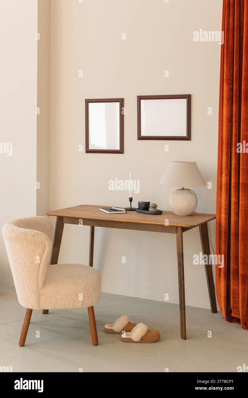 Two empty picture frames hanging over a desk in a stylish modern living ...