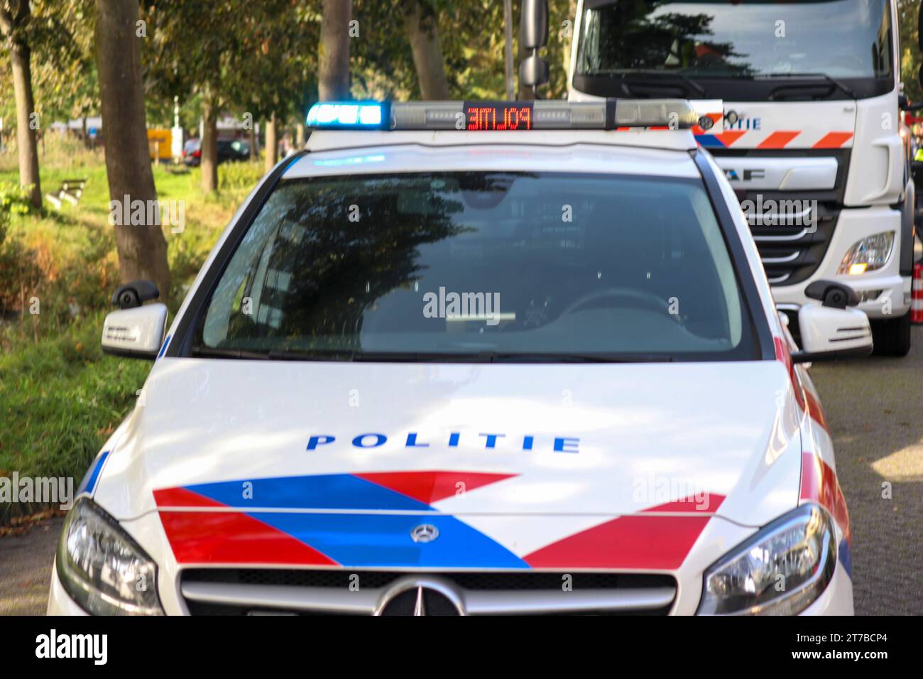 Police car in the Netherlands with blue flashlights and stop sign lit ...