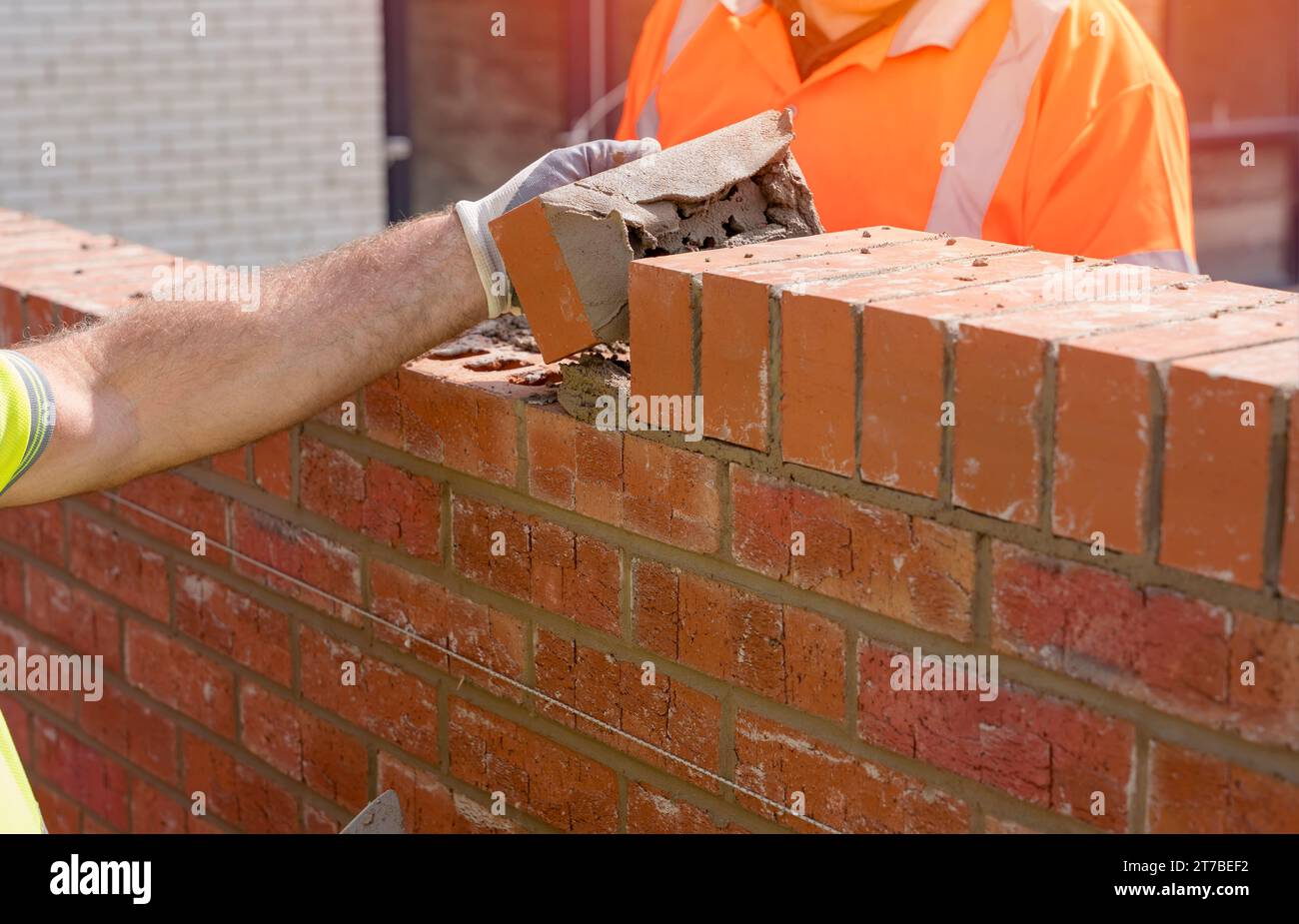 Bricklayers Laying Bricks On Mortar Bricklayer Making Finishing Touches To The Brick Wall And