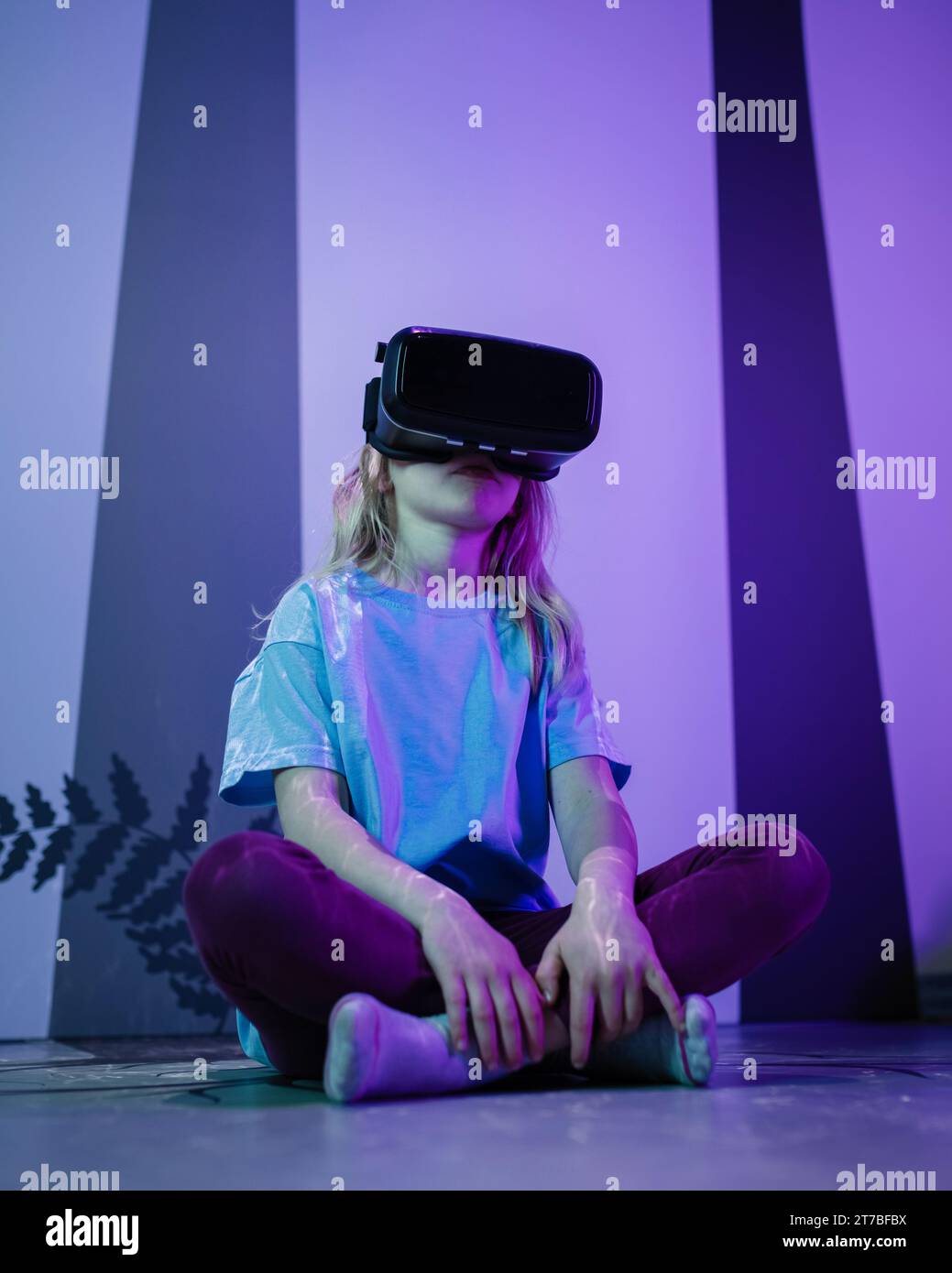 Female child using new technologies, having fun wearing virtual reality ...