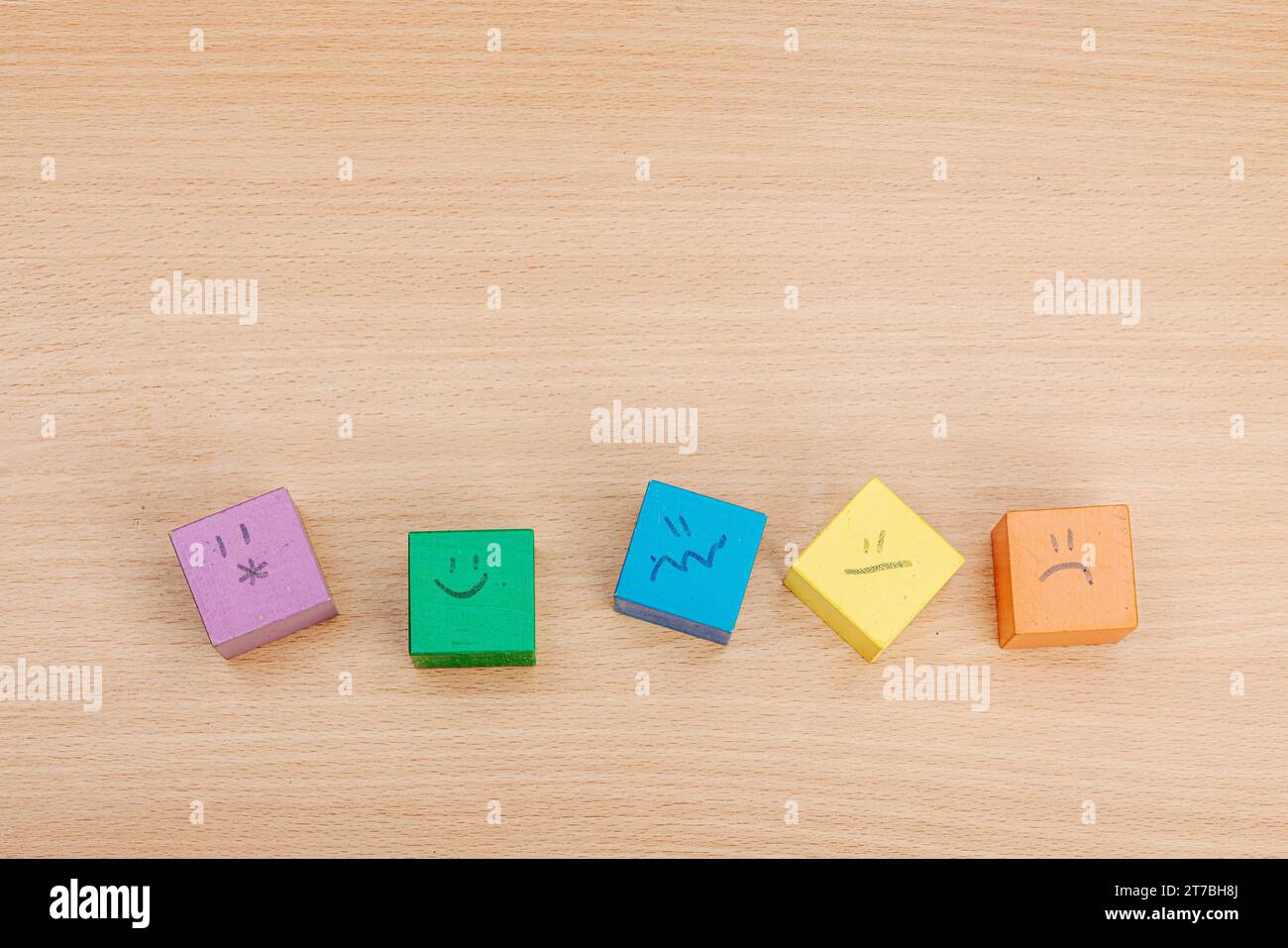 World mental health day. wooden cubes with different emotions. Feedback ...