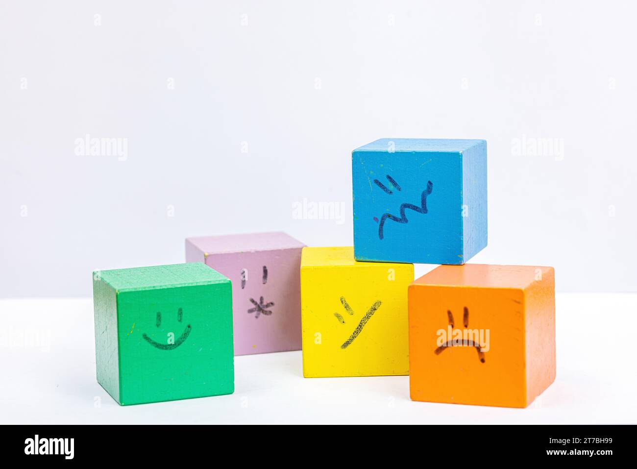 World mental health day. wooden cubes with different emotions. Feedback ...