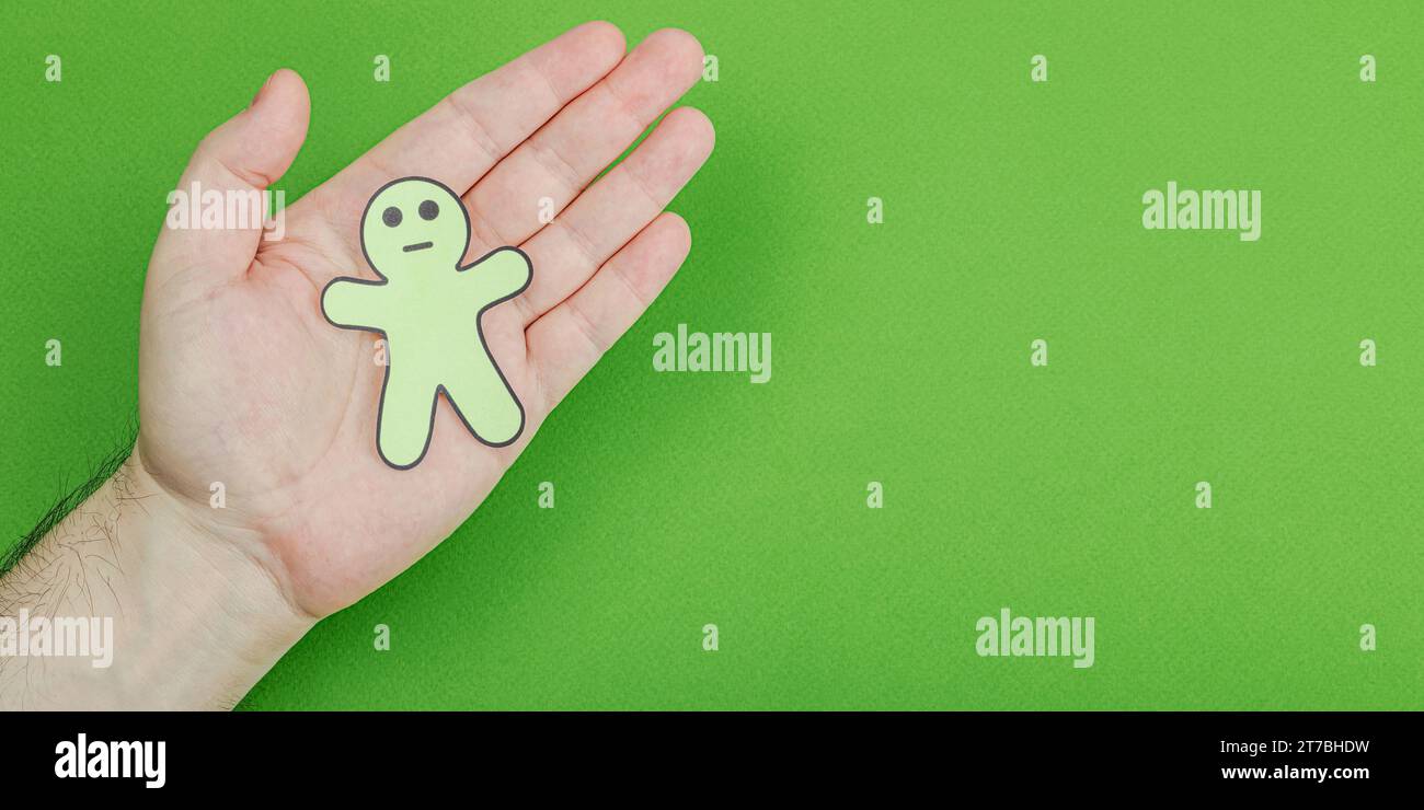 World mental health day. Male hands holding paper men figures with ...