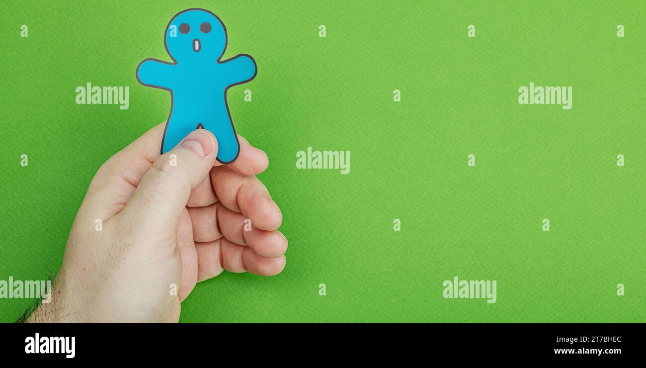 World mental health day. Male hands holding paper men figures with ...