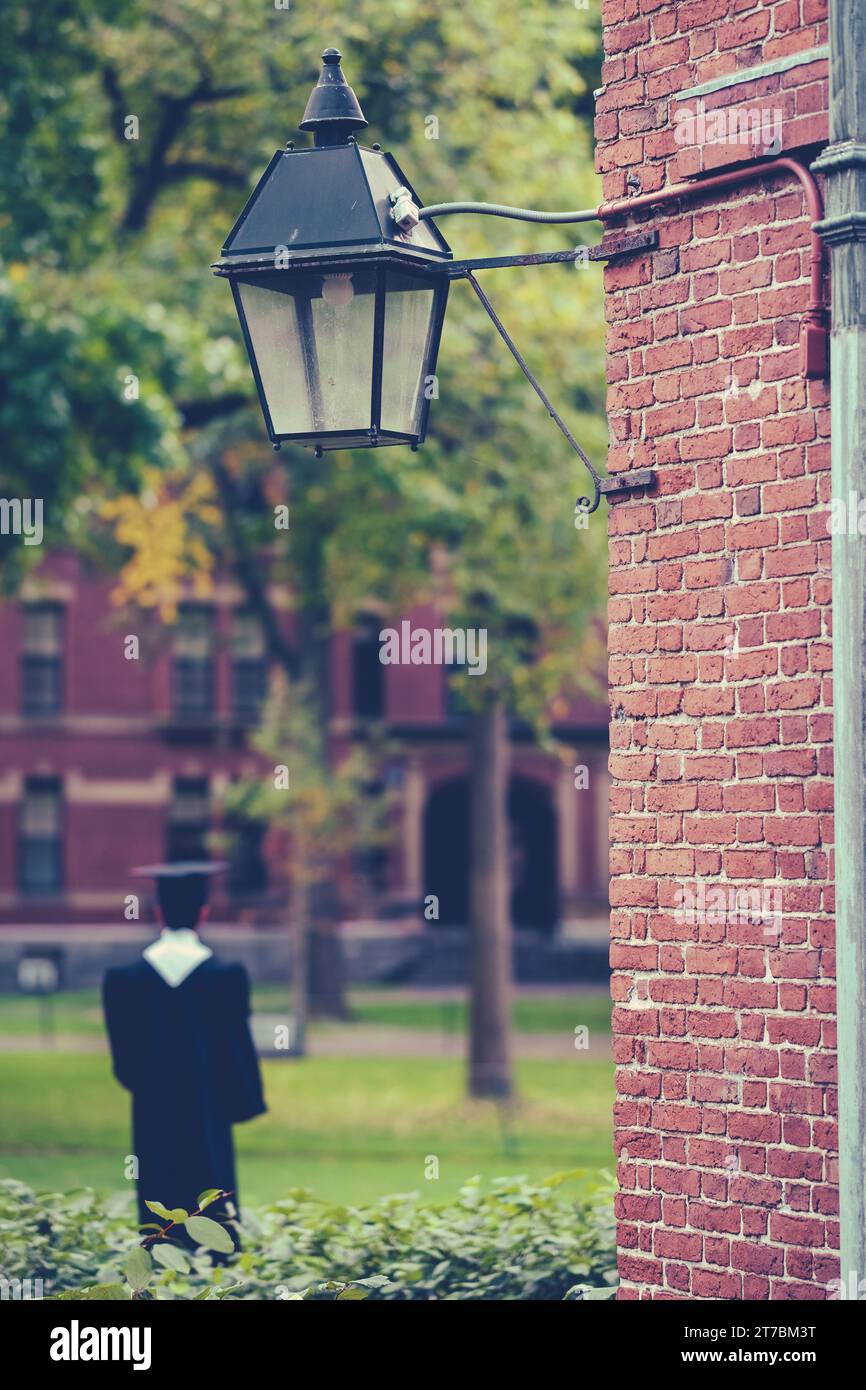 A Student In Formal Gown And Mortarboard In A Courtyard At A ...