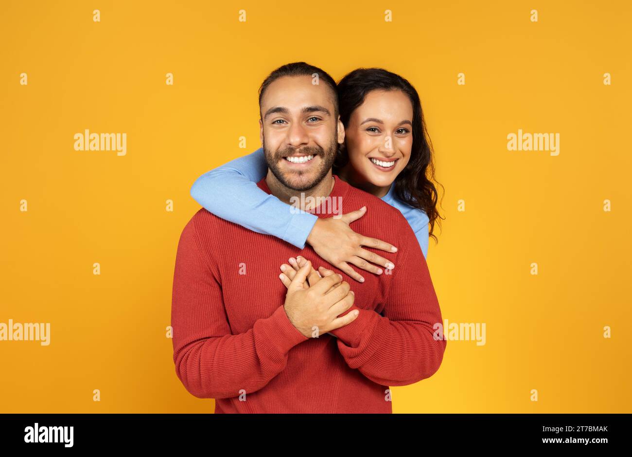 Portrait of joyful millennial woman hugging her boyfriend from behind Stock Photo - Alamy