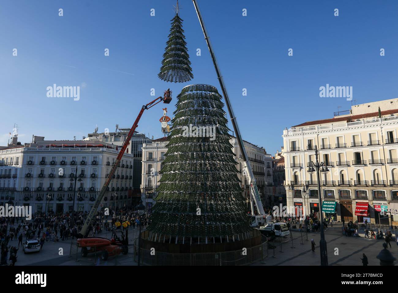 Operators lift the upper cone of the Christmas tree to install it on ...