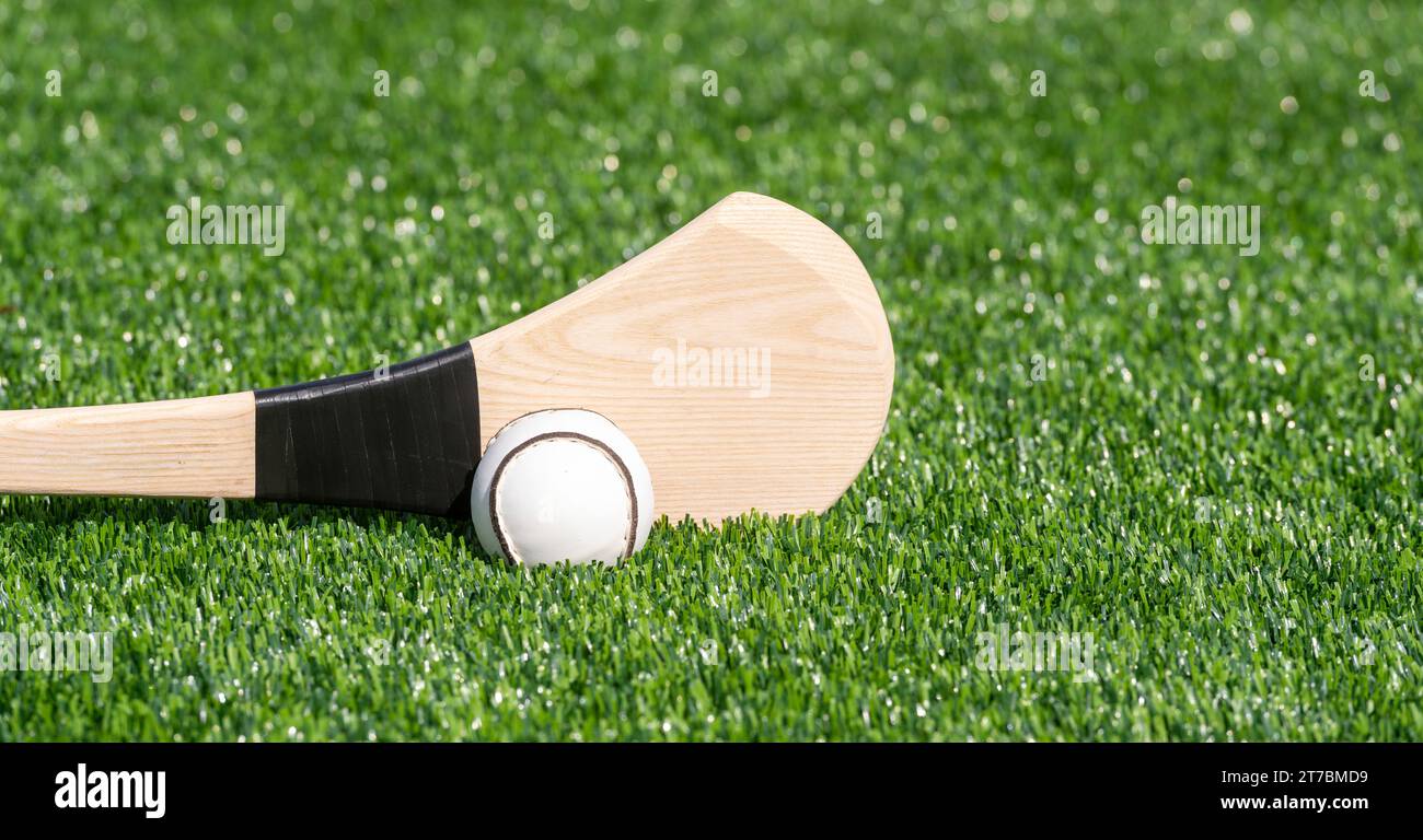 Hurling bat and sloitar on green grass. Horizontal sport theme poster ...