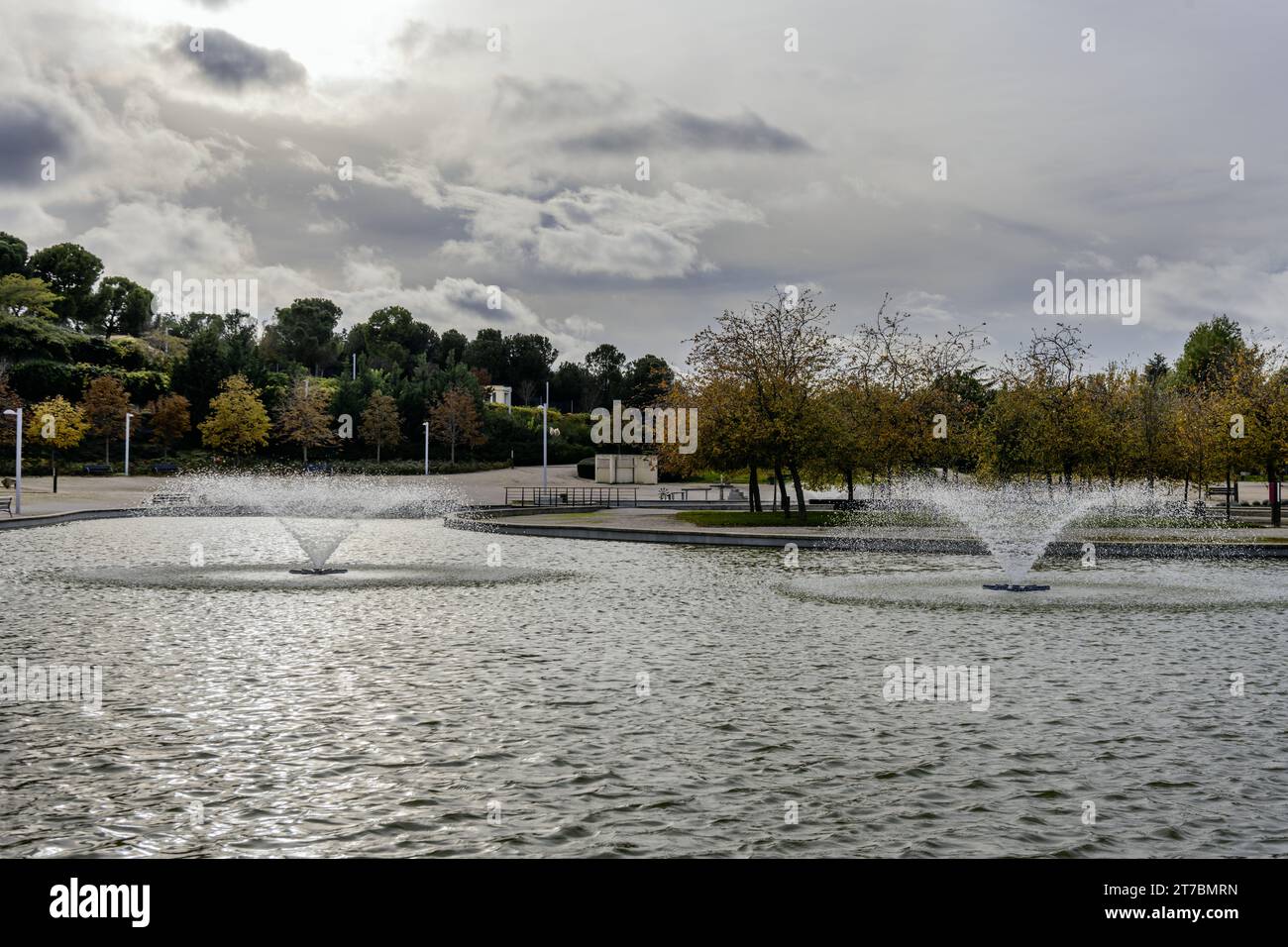 twin fountains in a small artificial lake within an urban park Stock ...