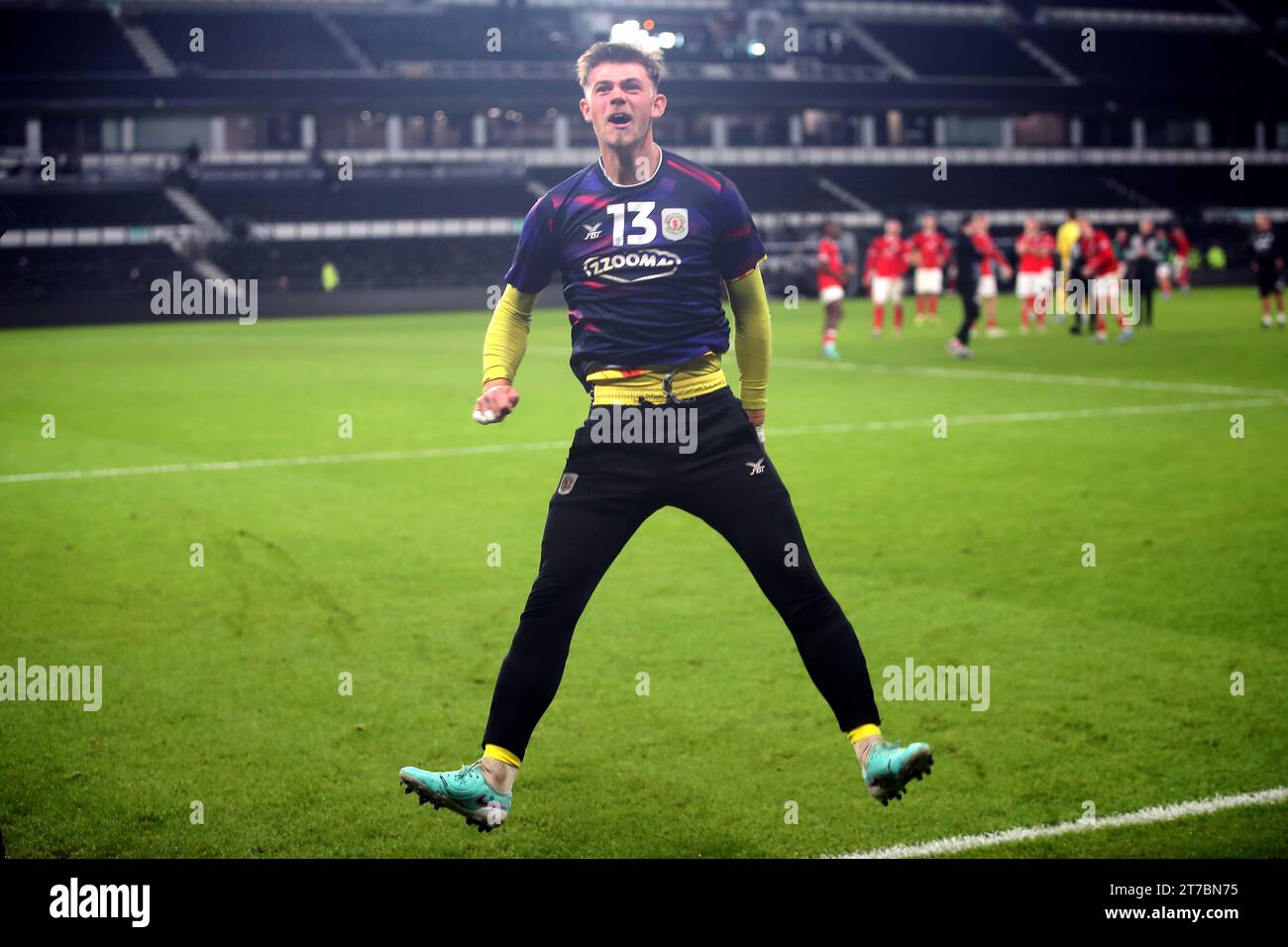 Crewe Alexandra goalkeeper Tom Booth celebrates victory in front of the ...