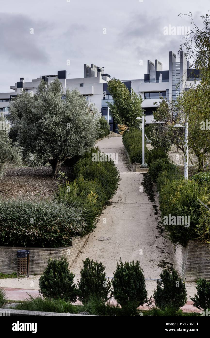 A long sandy path to walk on a slope within an urban park Stock Photo ...