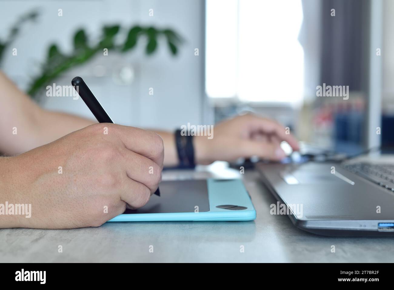Graphic designer working in office with digital control wheel and ...