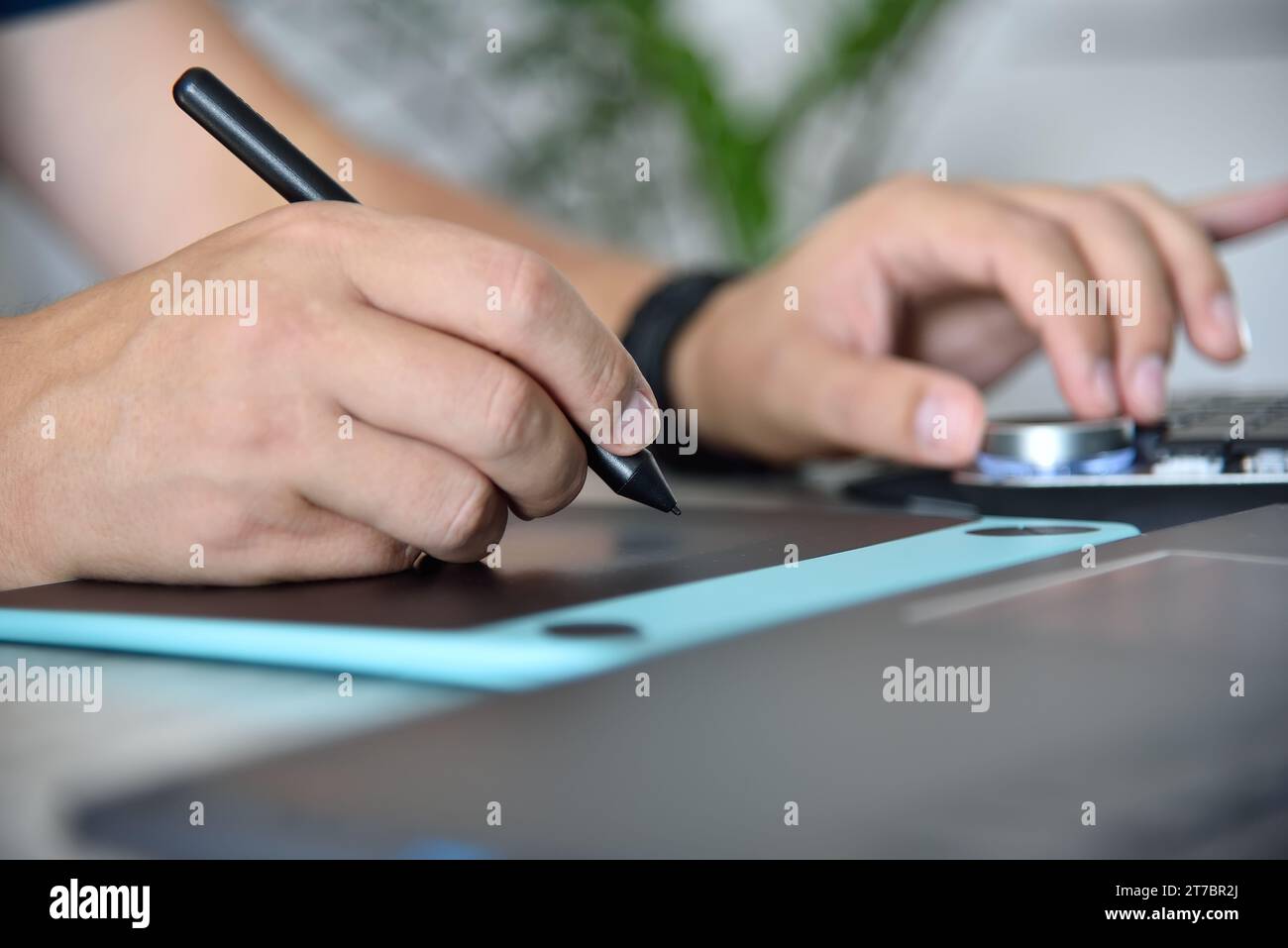 Designer drawing on graphic tablet and navigation control wheel ...