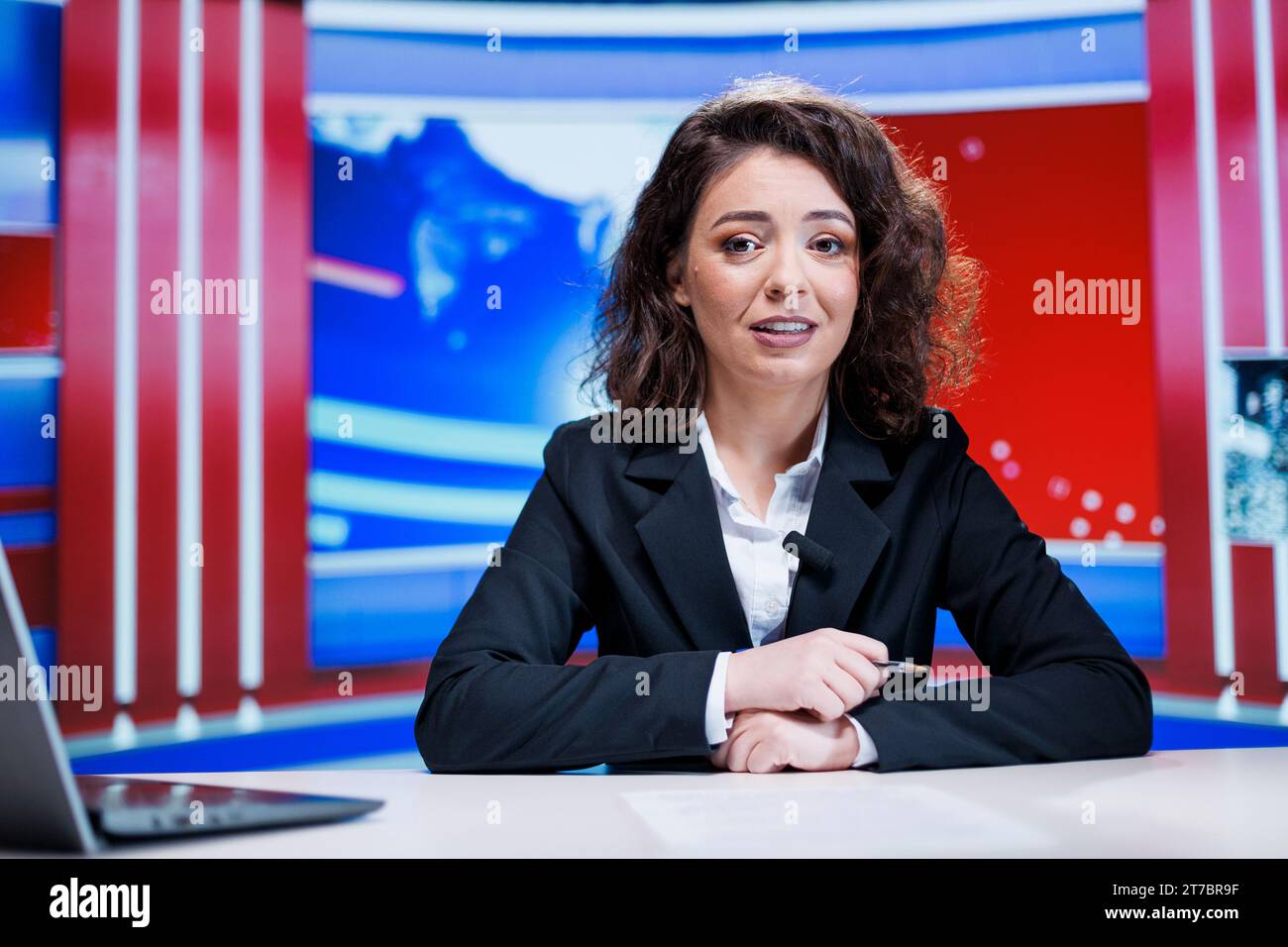 Media presenter utilizing news articles to produce newscast, reporting live incidents in studio ...