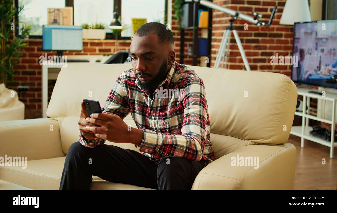 Person scrolling on phone with tv on hi-res stock photography and ...