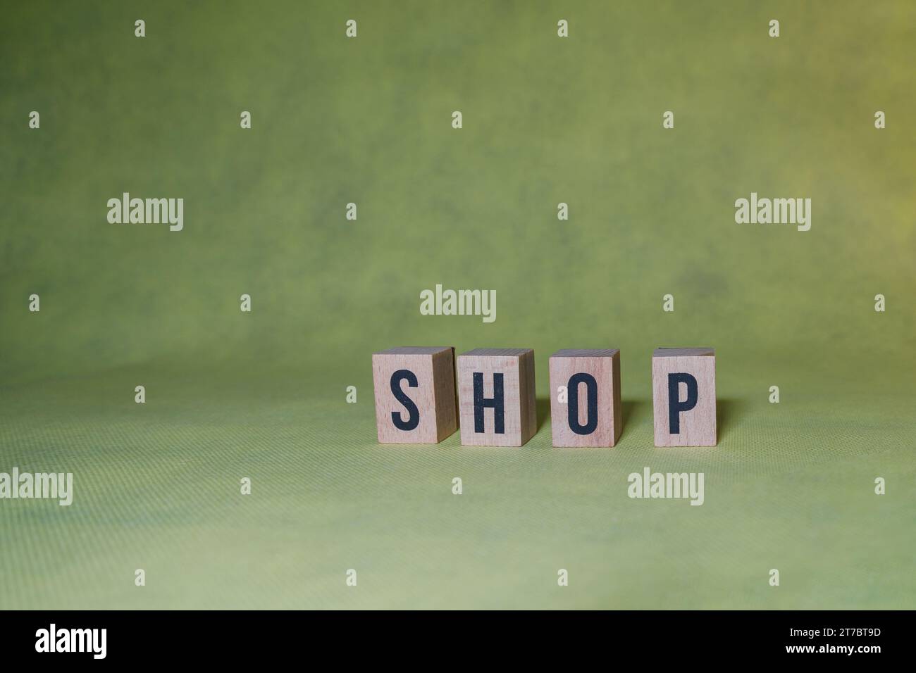 SHOP word constructed by wooden letters on yellow background with copy ...