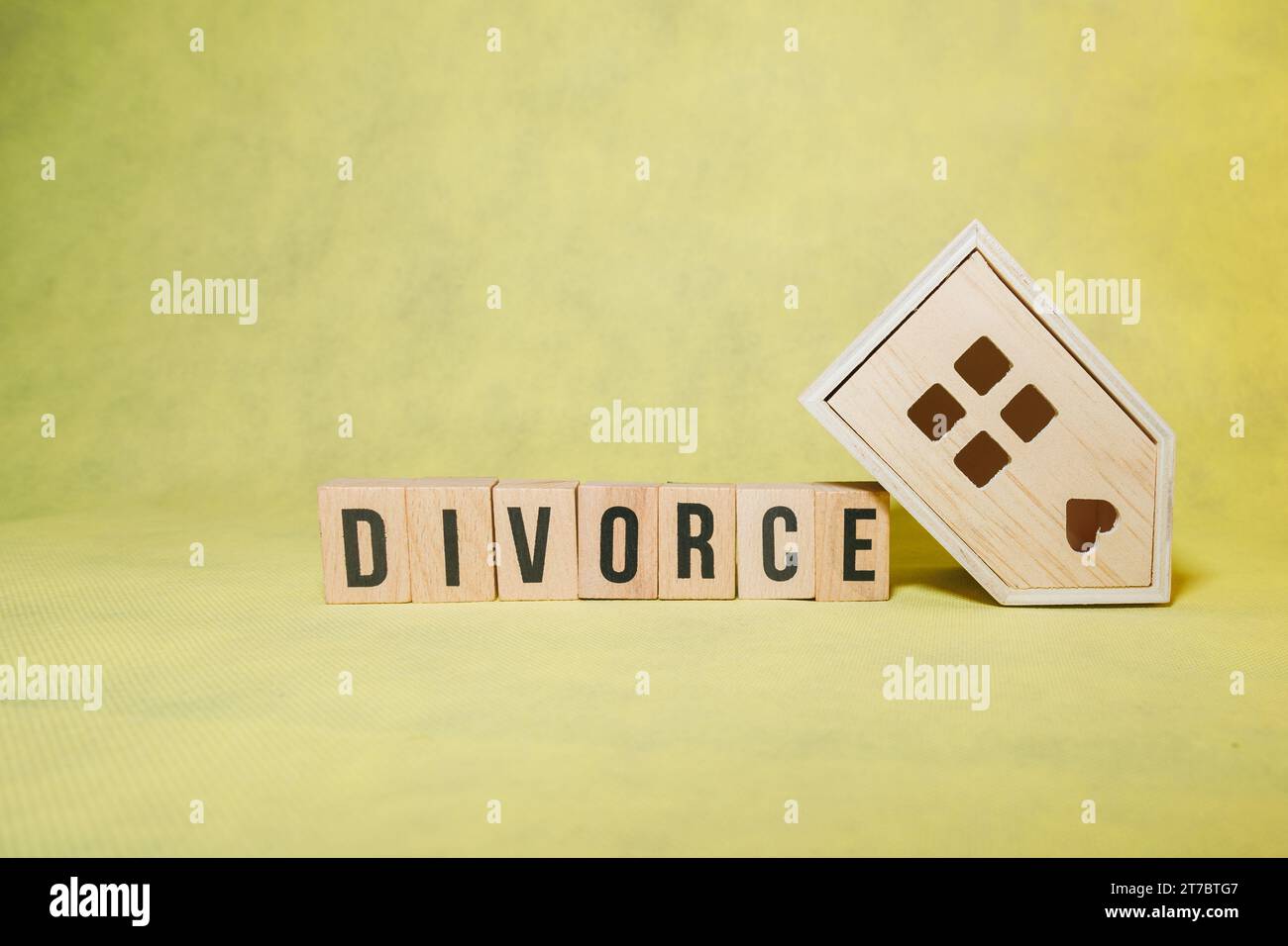wooden letters with the word Divorce and an upside down house as a sign ...