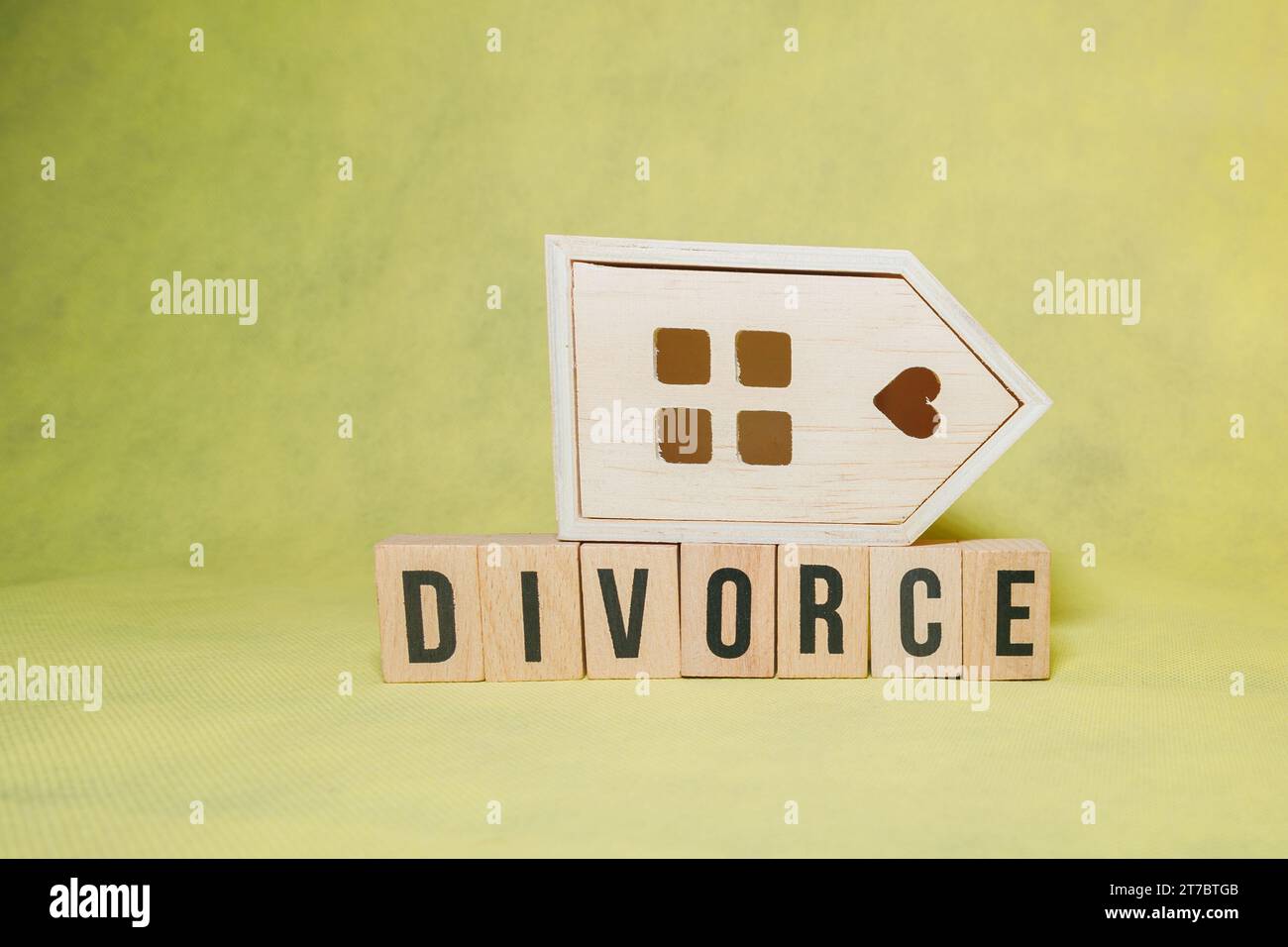 wooden house lying down with wooden letters Divorce with yellow ...