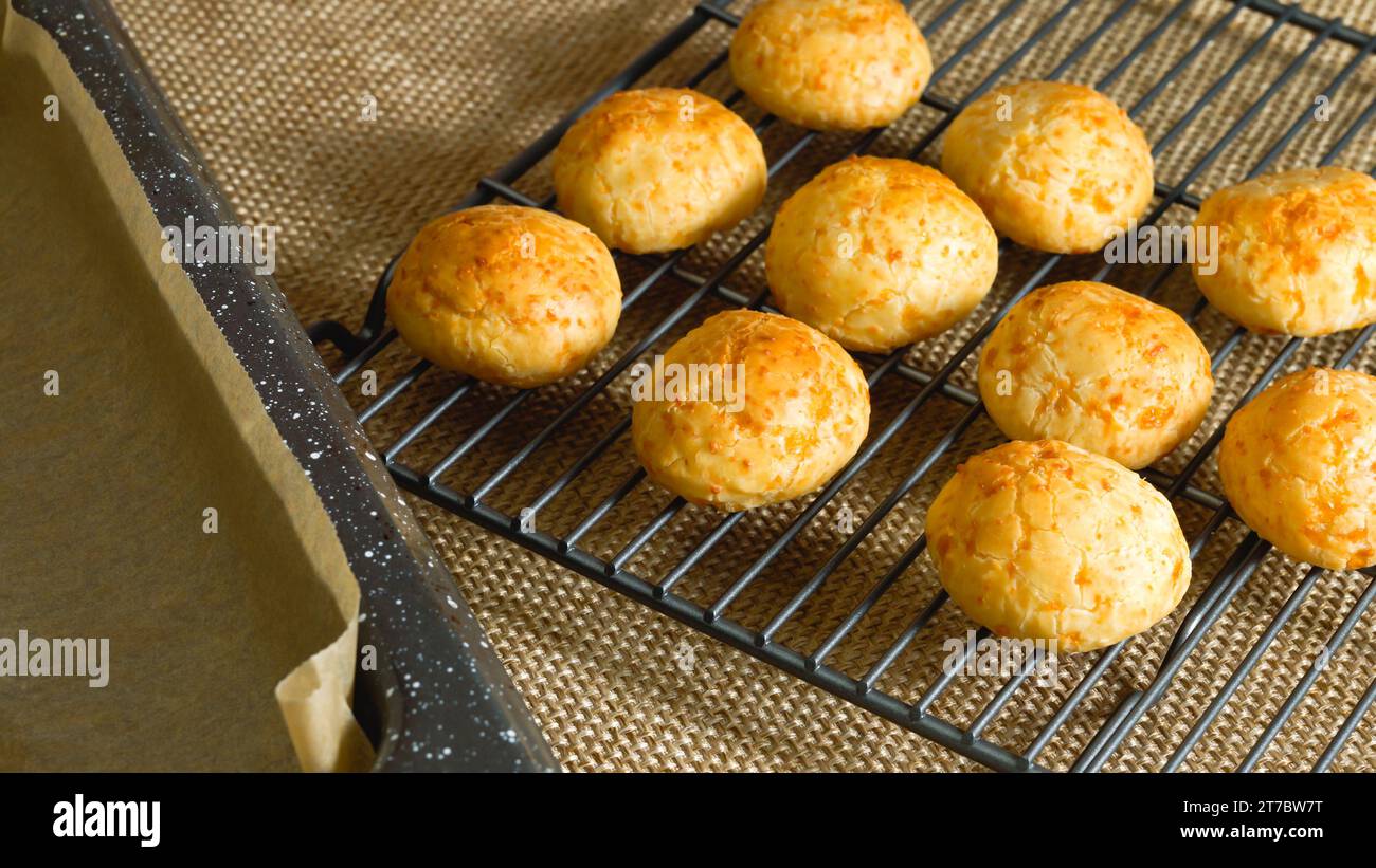 Traditional Brazilian cheese bread balls on cooling rack close-up on ...