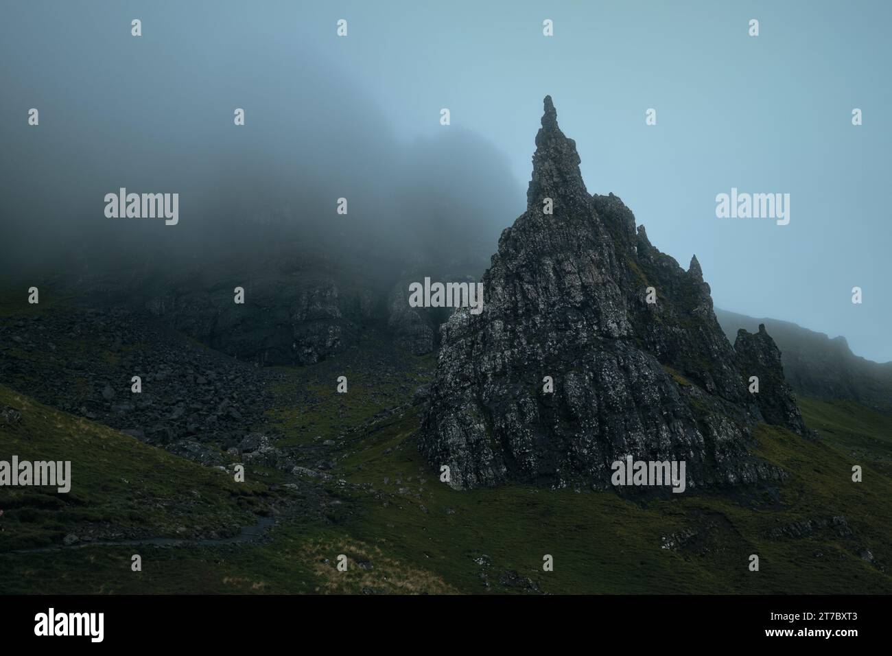 Atmospheric view of high sharp cliffs covered in fog. The Old Man of ...