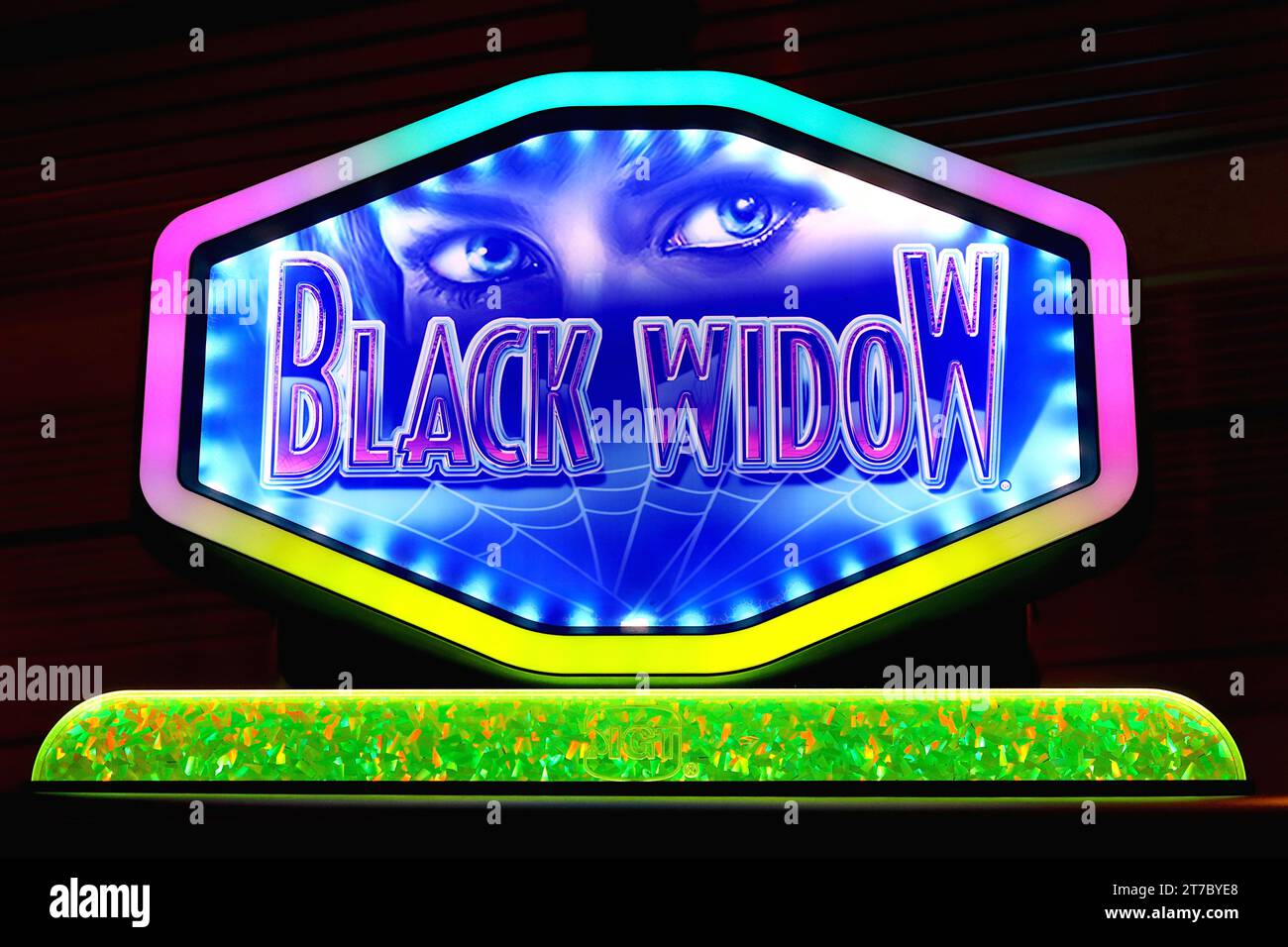 Mounted on an arcade gaming machine, an illuminated header panel with ...