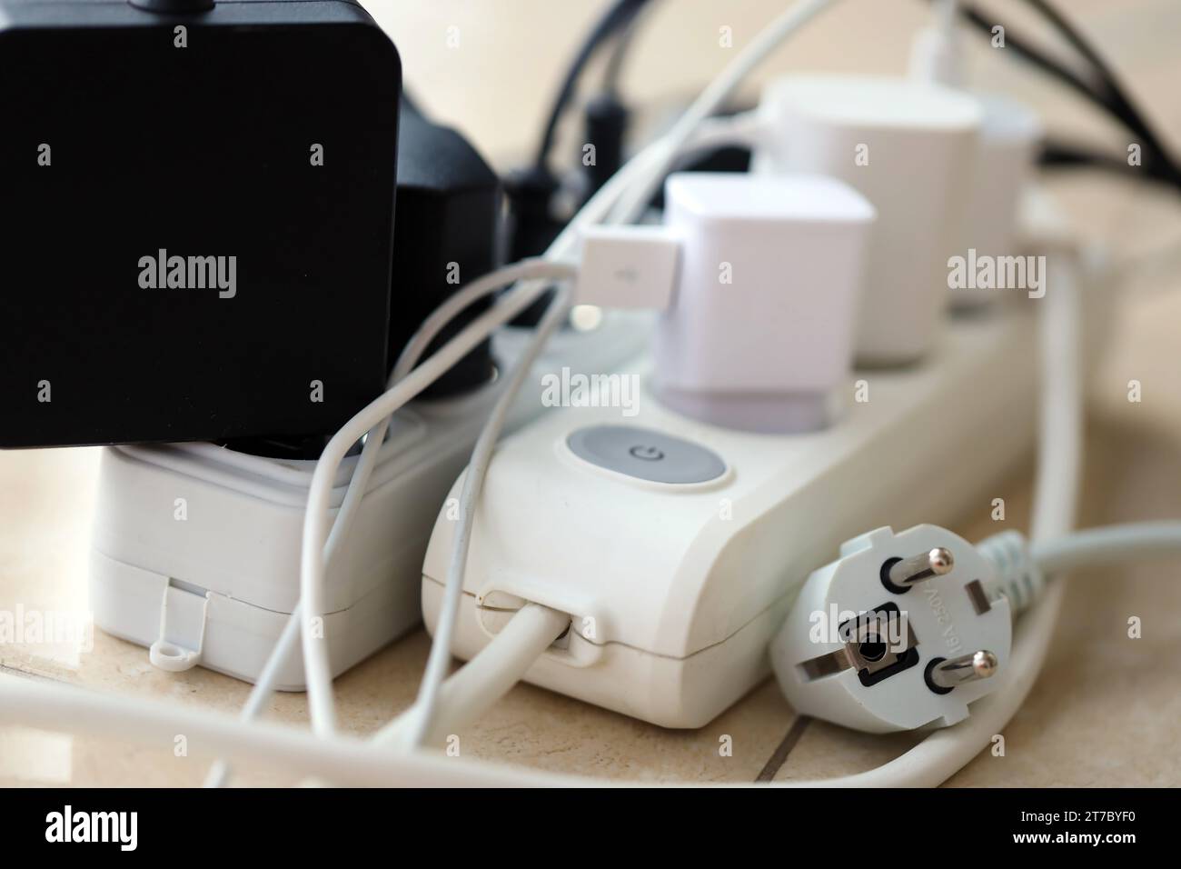 Overloaded power boards. Power strips with different electrical plugs ...