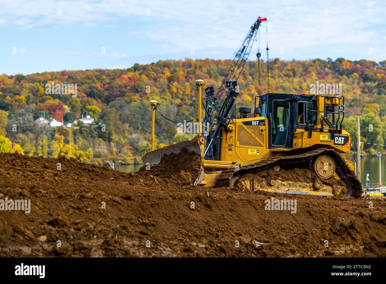 A dozer pushes dirt to prepare a construction site for the U.S. Army ...