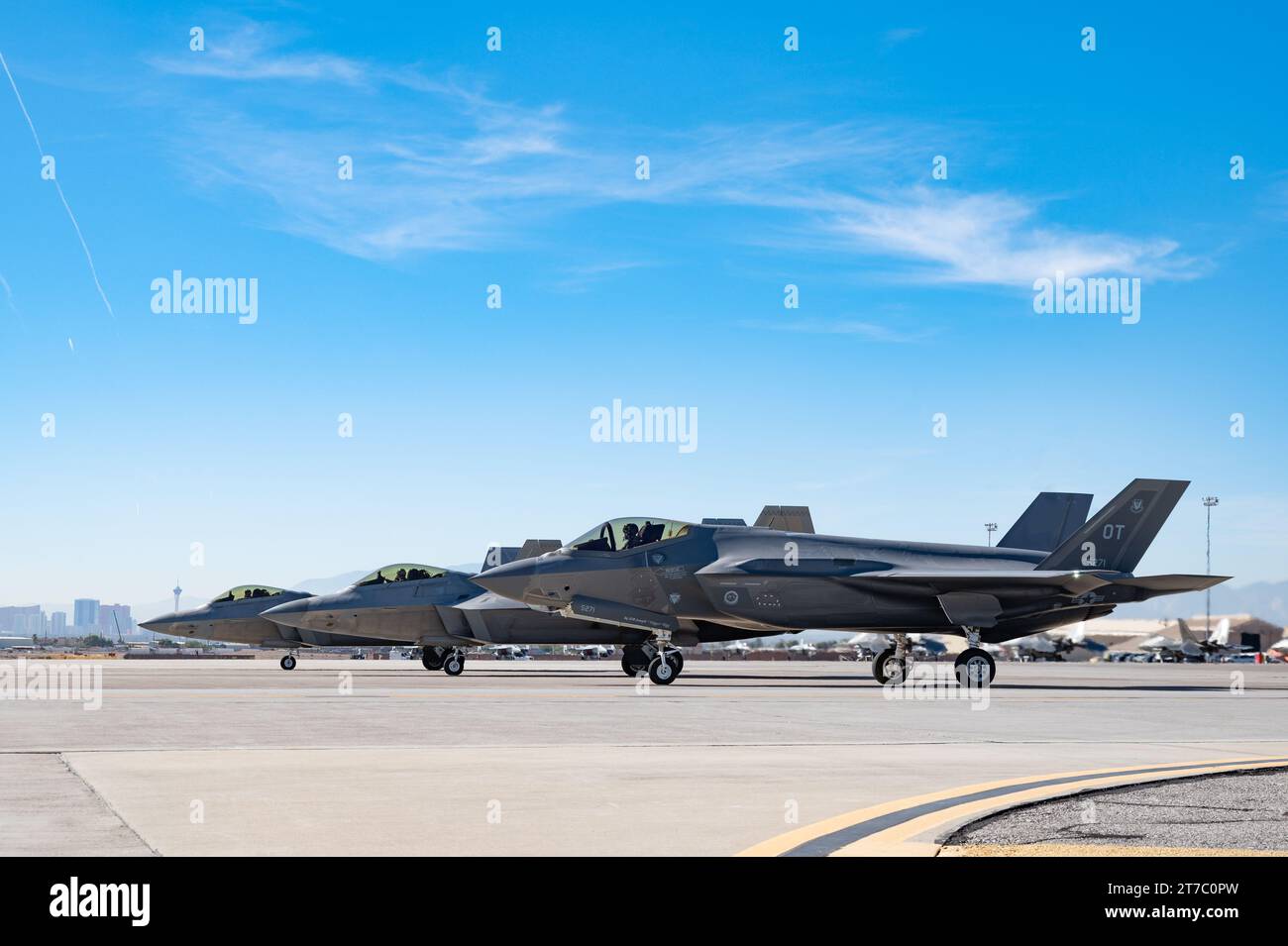 Three F-35 Lightning II aircraft sit on the taxiway at Nellis Air Force ...