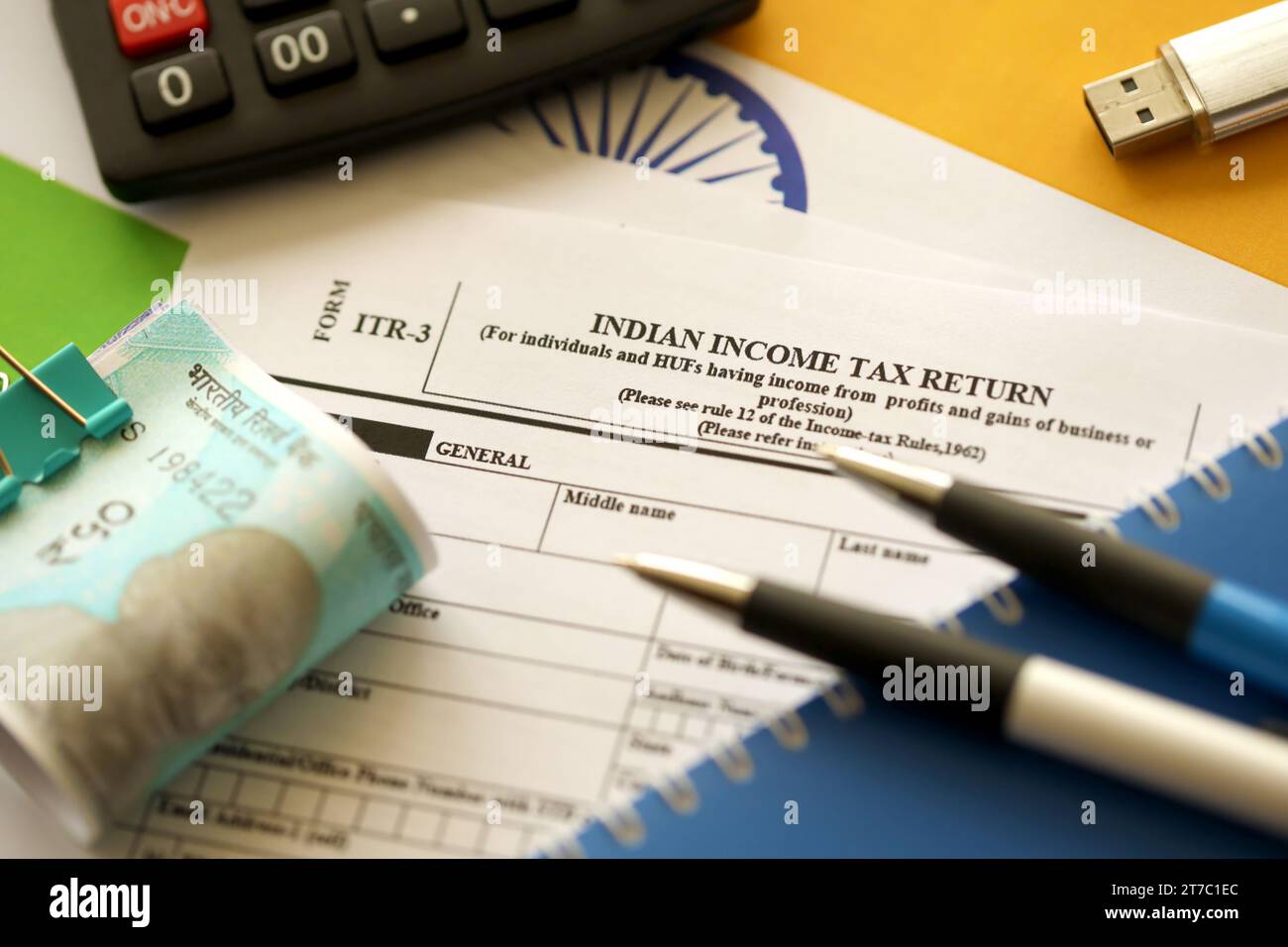 Indian income tax return blank form with pen and indian rupees bills on ...