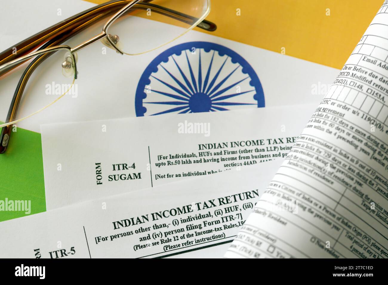 Indian income tax return blank form with pen and indian rupees bills on ...