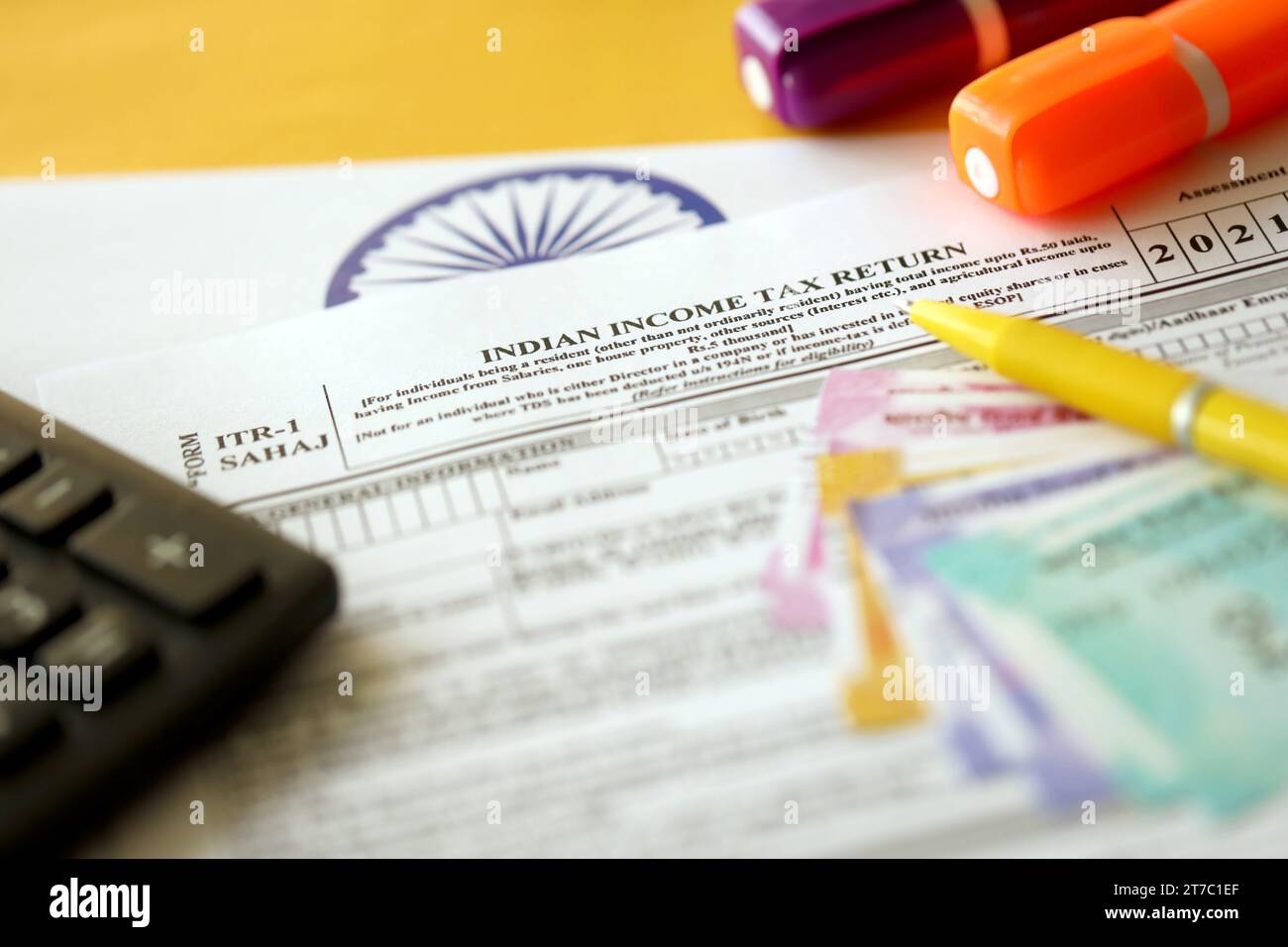 Indian income tax return blank form with pen and indian rupees bills on ...