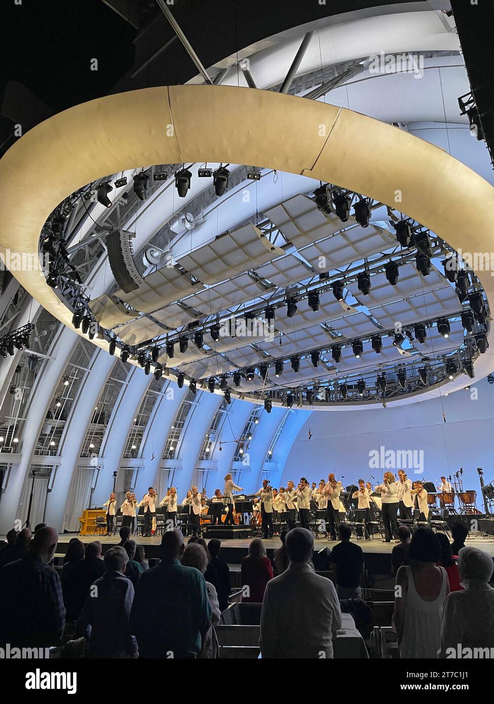 Concert goers stand for the playing of the national anthem at the ...