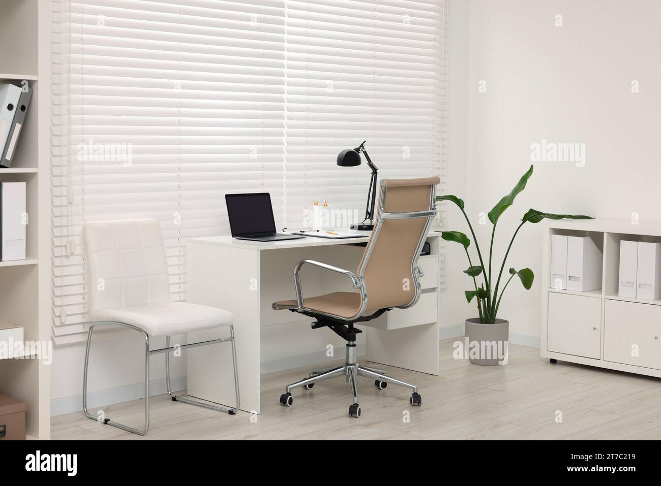 Doctor's workplace. Chairs, laptop and clipboard on table in clinic ...