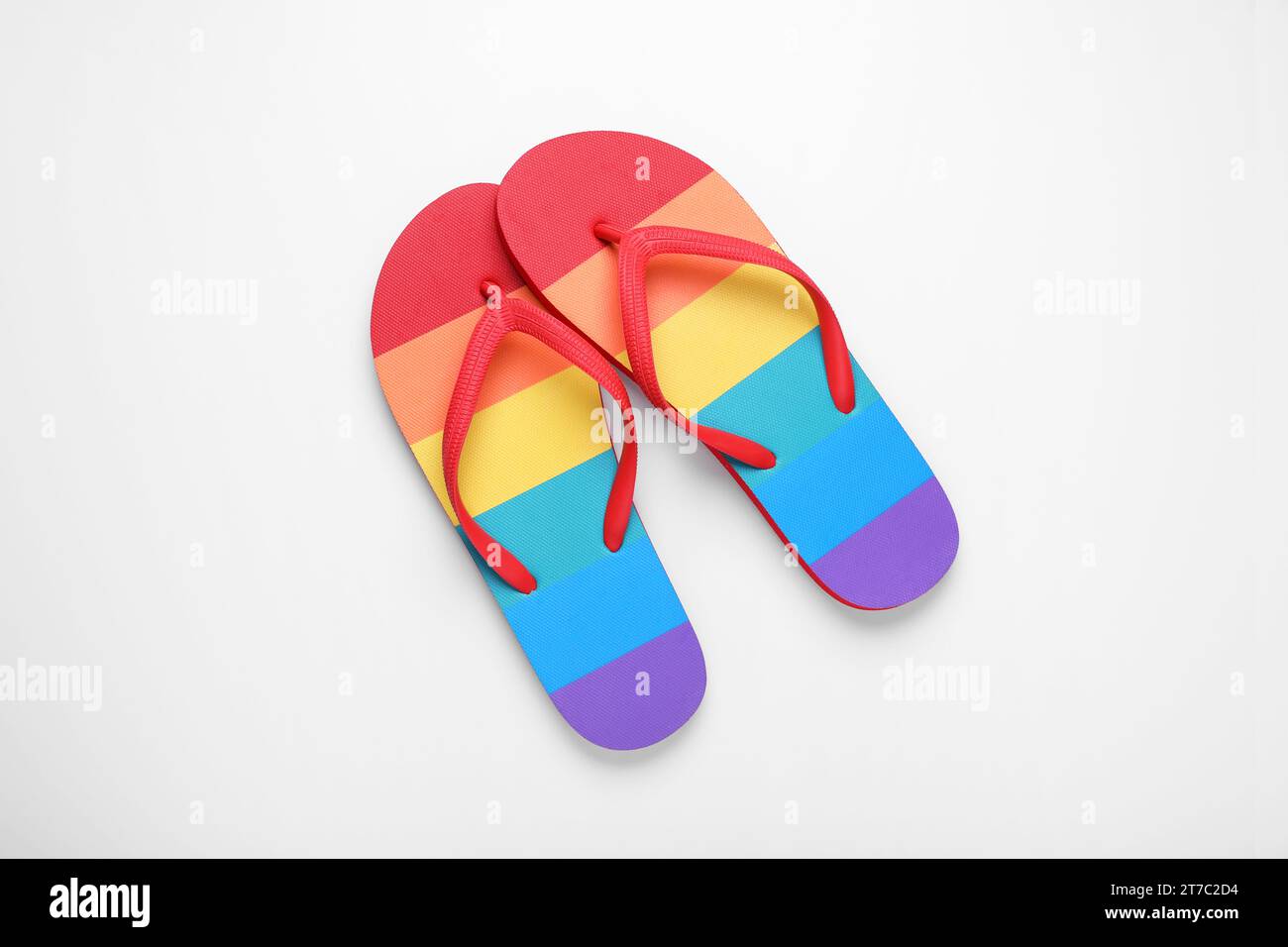 Stylish rainbow flip flops on white background, top view Stock Photo ...