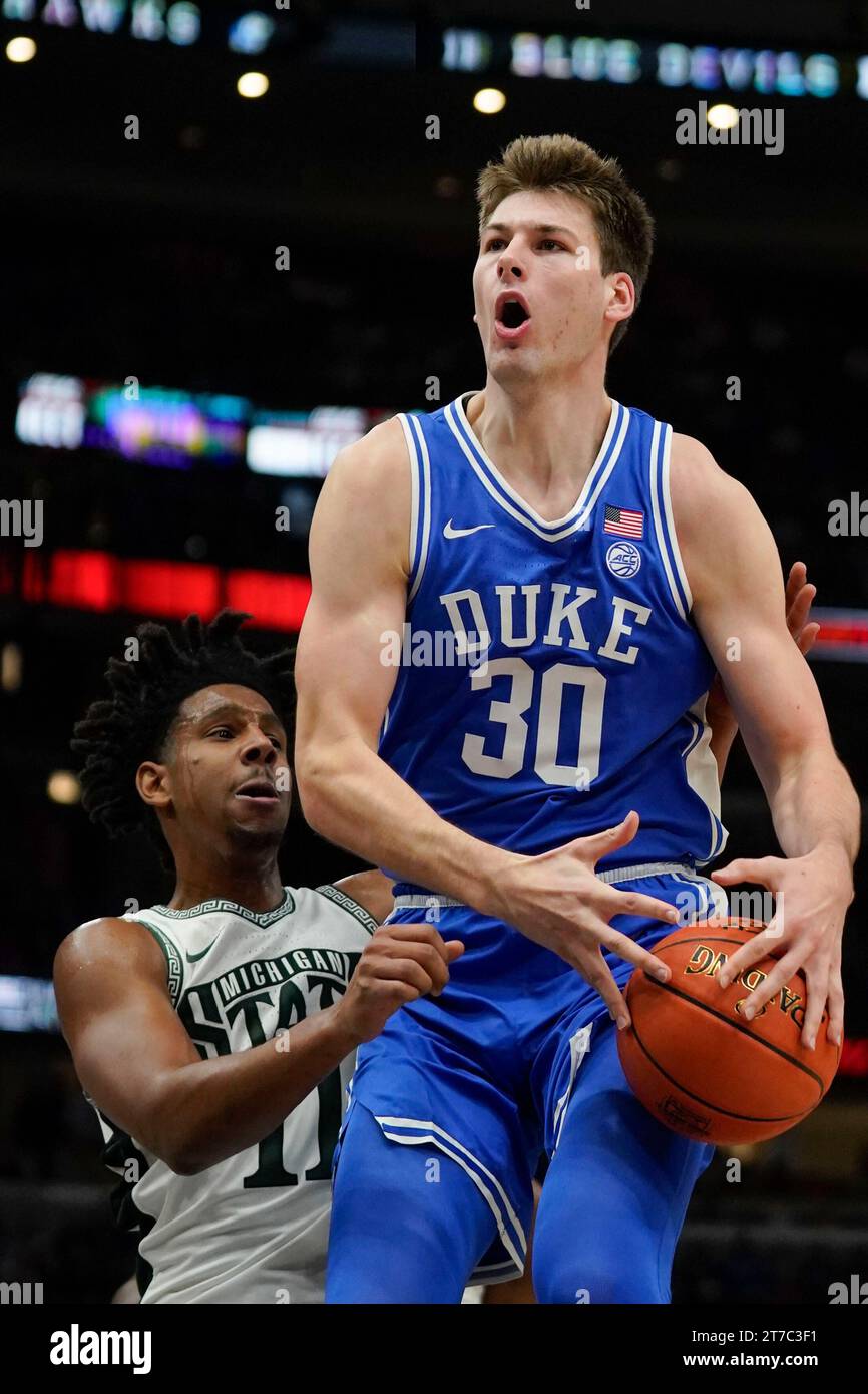 Duke center Kyle Filipowski (30) gets fouled by Michigan State guard A ...
