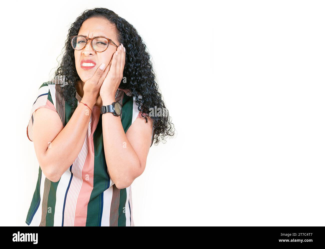 Young afro woman suffering with toothache isolated. Afro girl rubbing ...