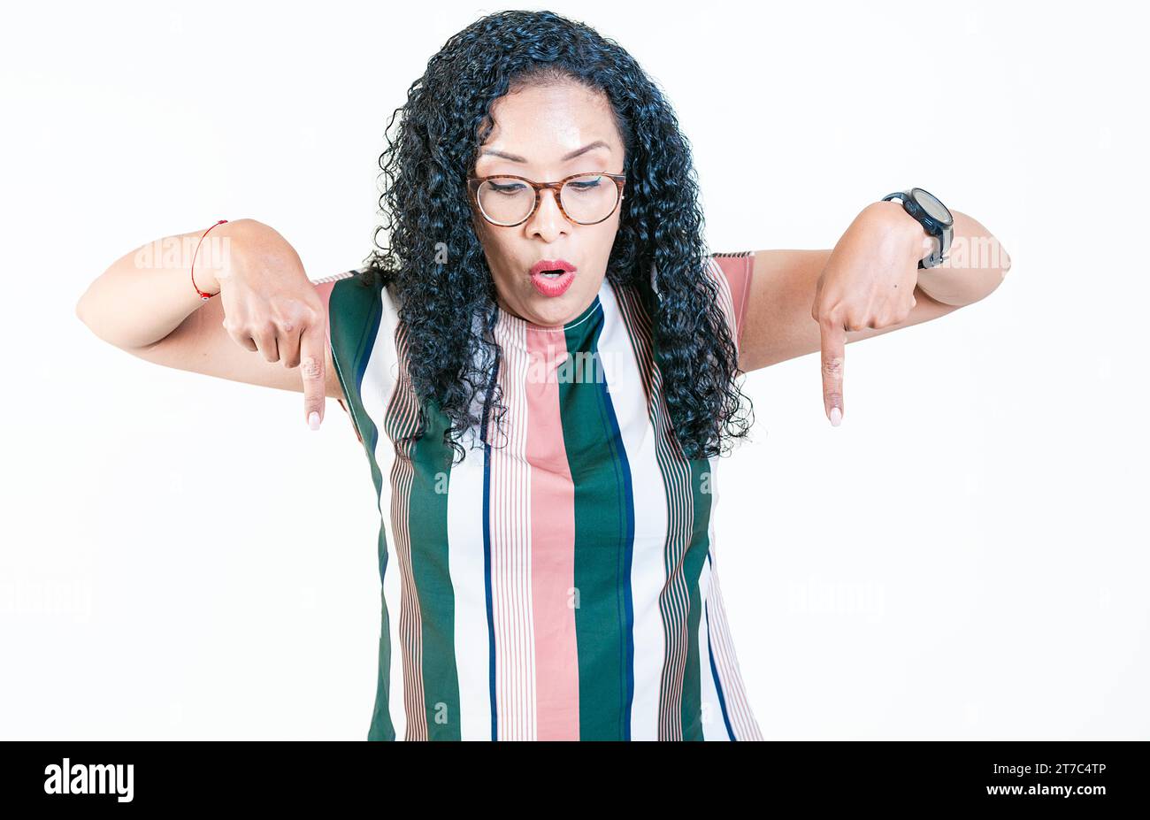 Surprised afro young woman pointing at advertising down isolated ...
