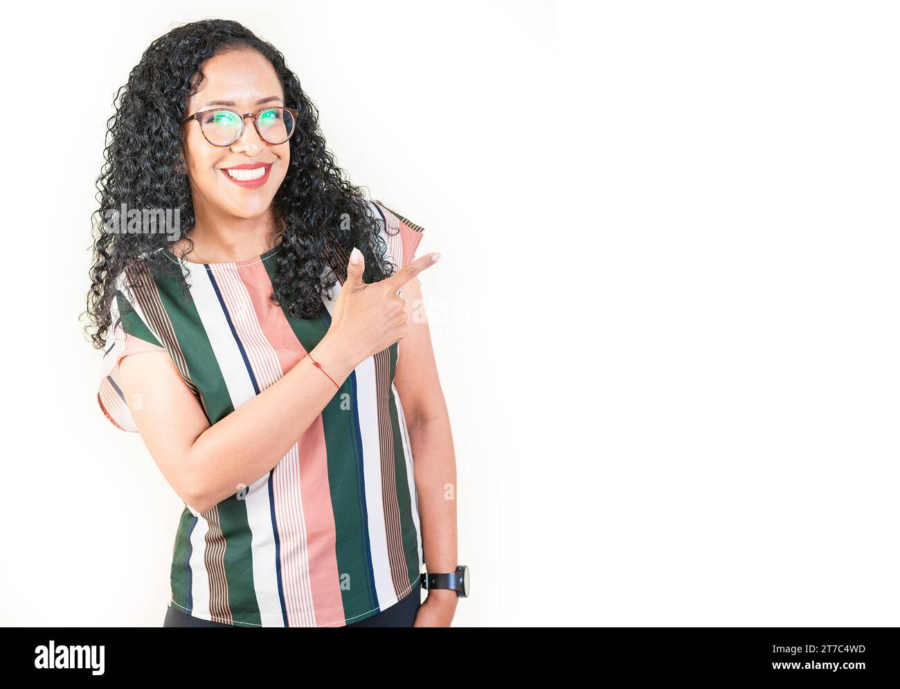 Smiling afro young woman pointing an advertising isolated. Beautiful ...
