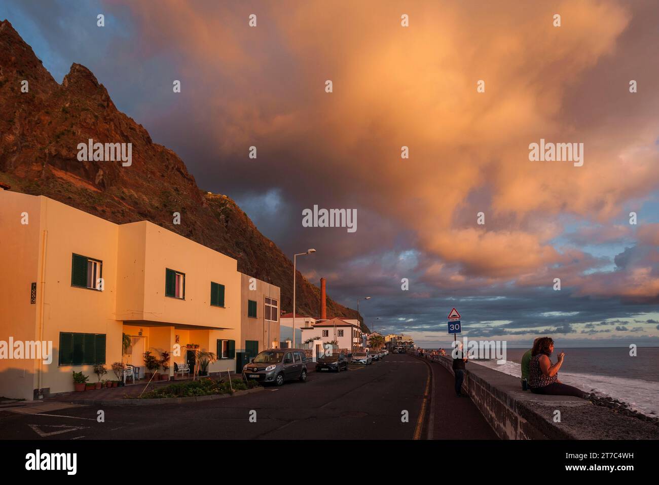 Coastal road with houses in Paul do Mar, evening light, dramatic cloud ...