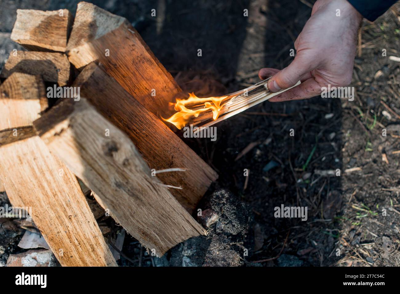 Top view man making bonfire Stock Photo - Alamy