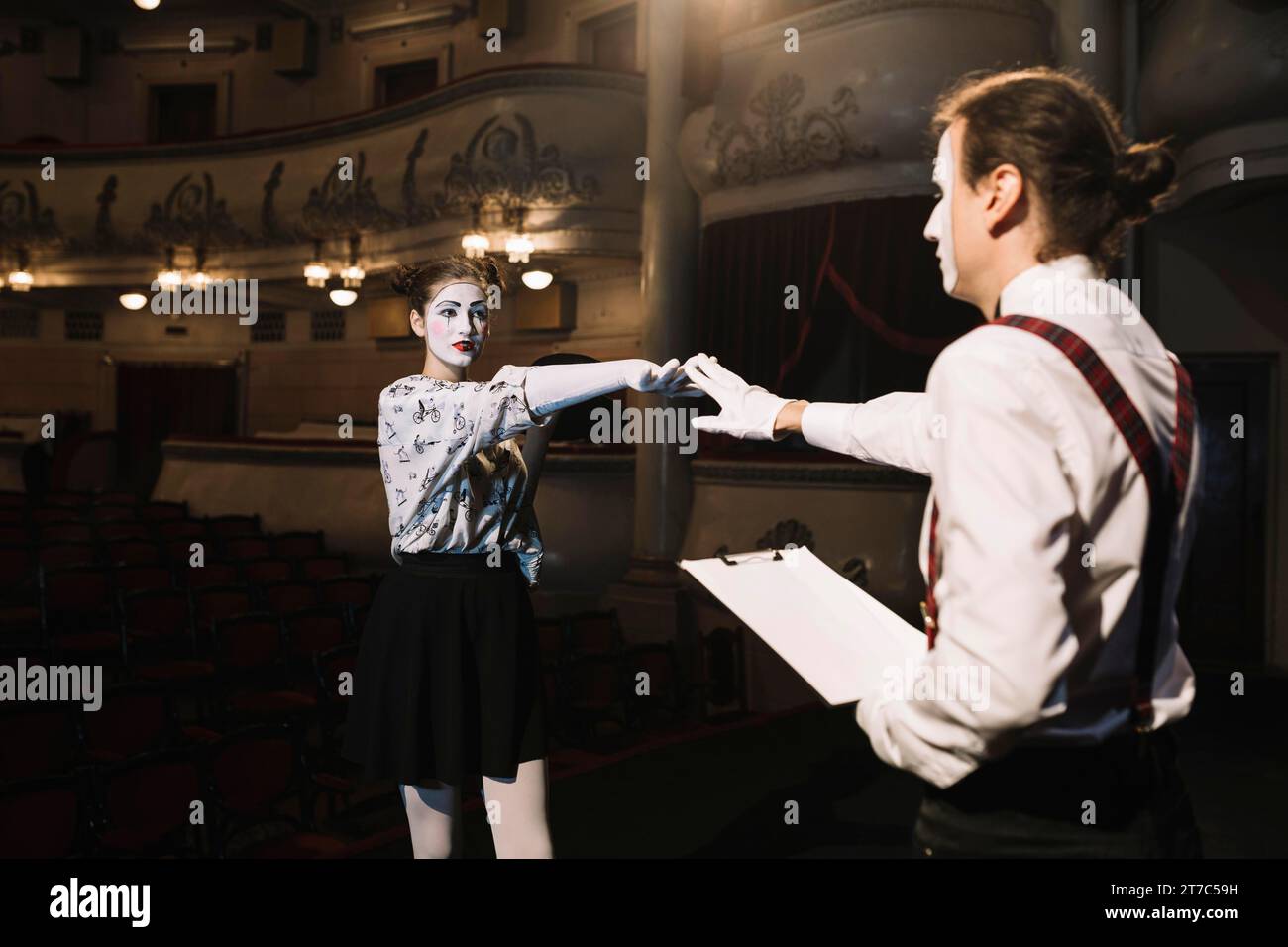 Two male female mime artist rehearsing stage auditorium Stock Photo - Alamy