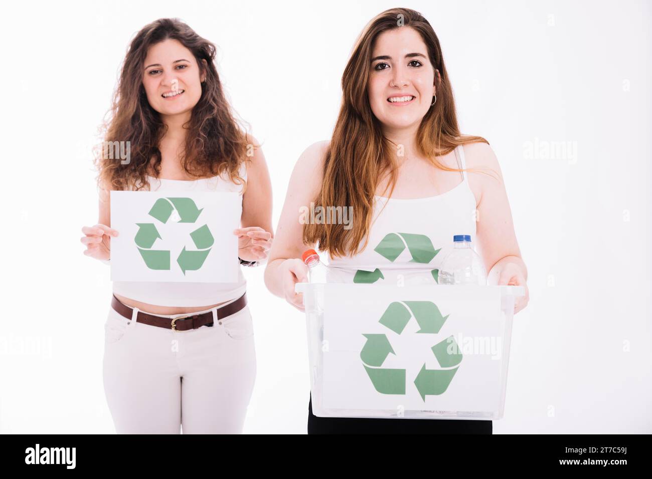Two woman holding recycle placard crate against white background Stock ...