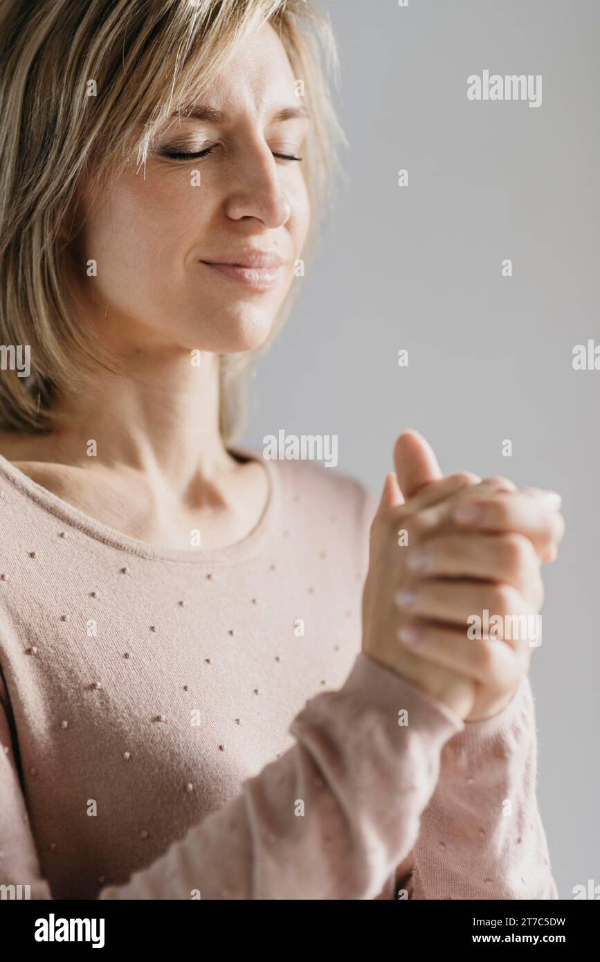 Woman praying alone home Stock Photo - Alamy